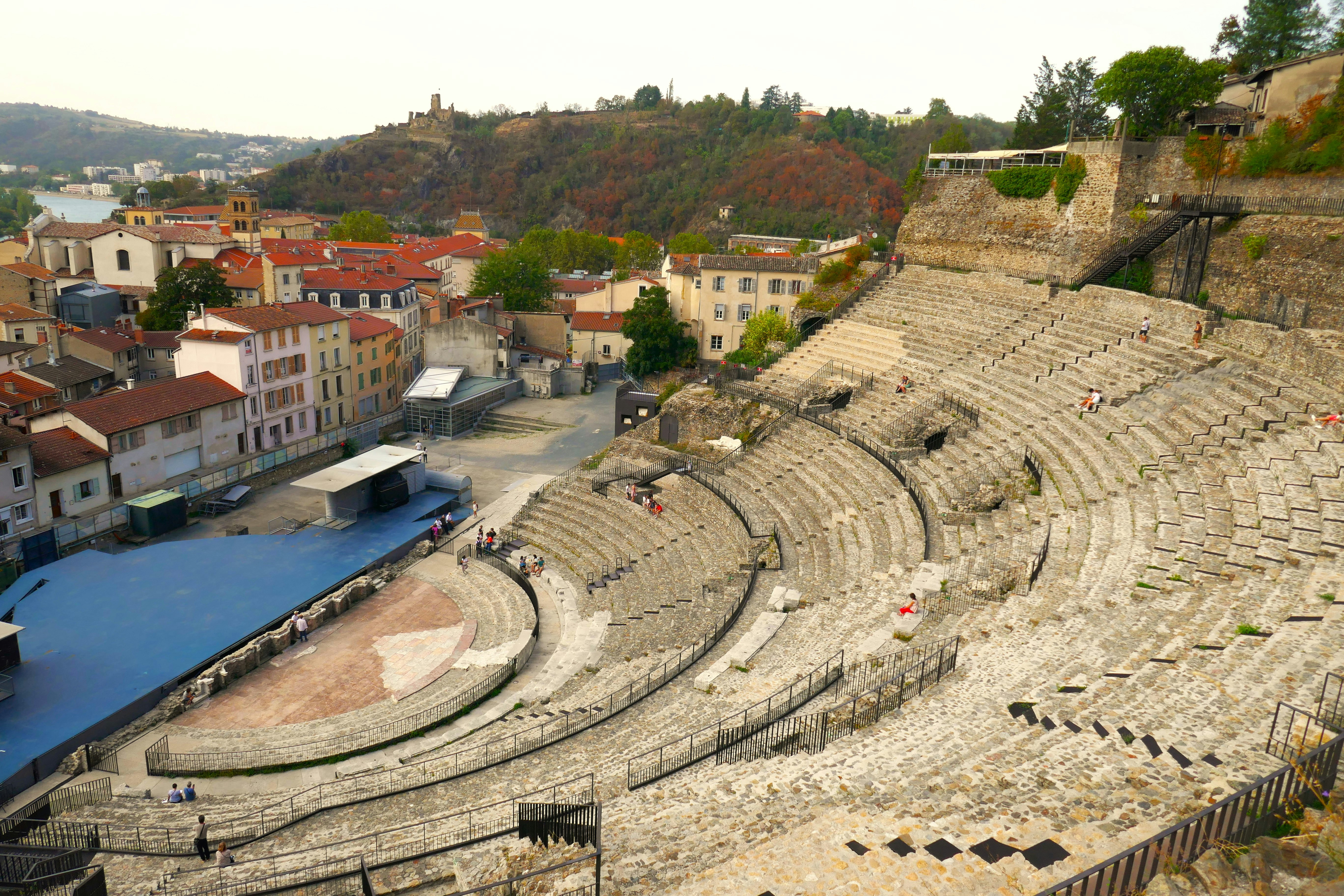 Stone amphitheater overlook: a sunlit hillside town