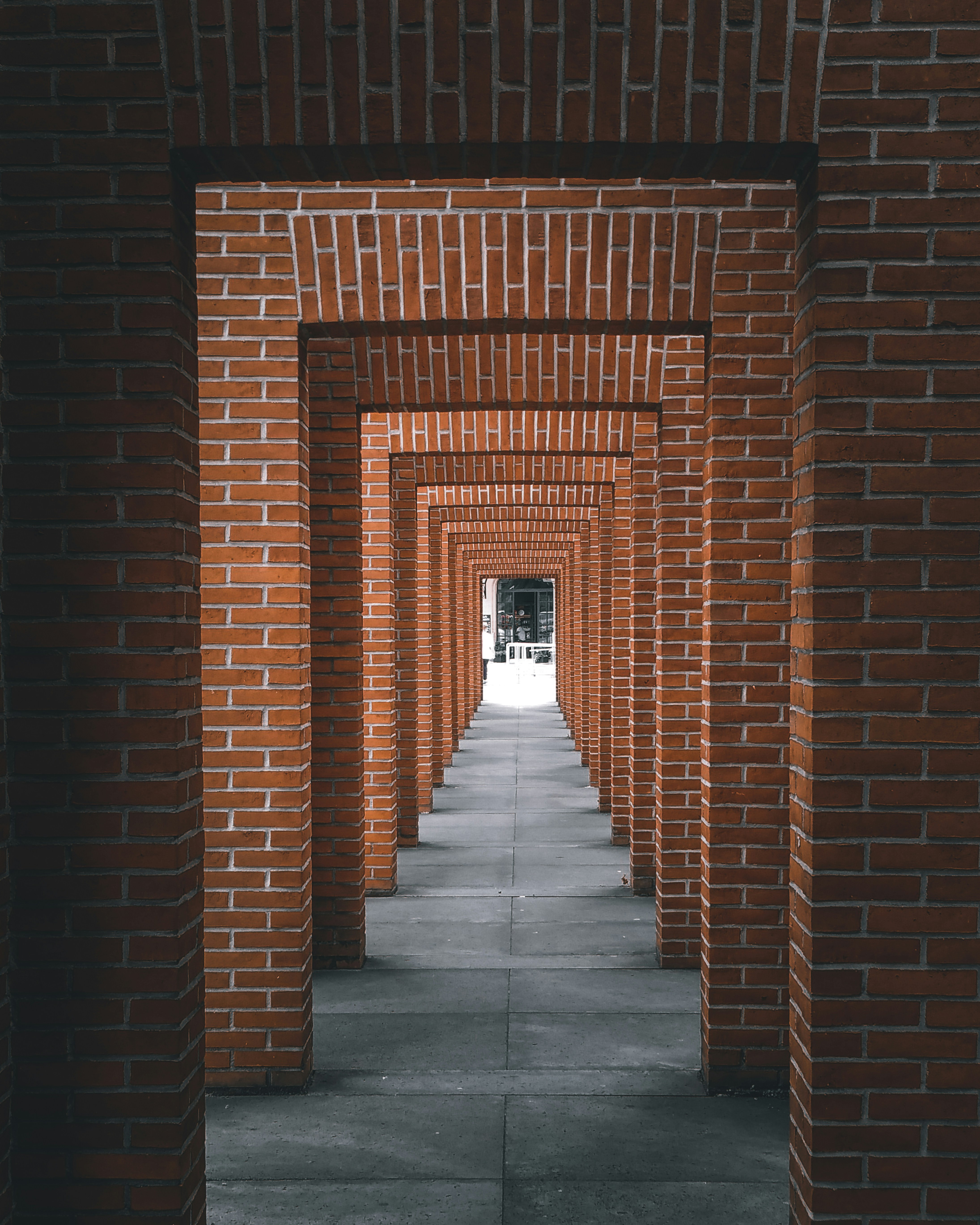 A walkway lined with red bricks leading to a building photo – Free ...
