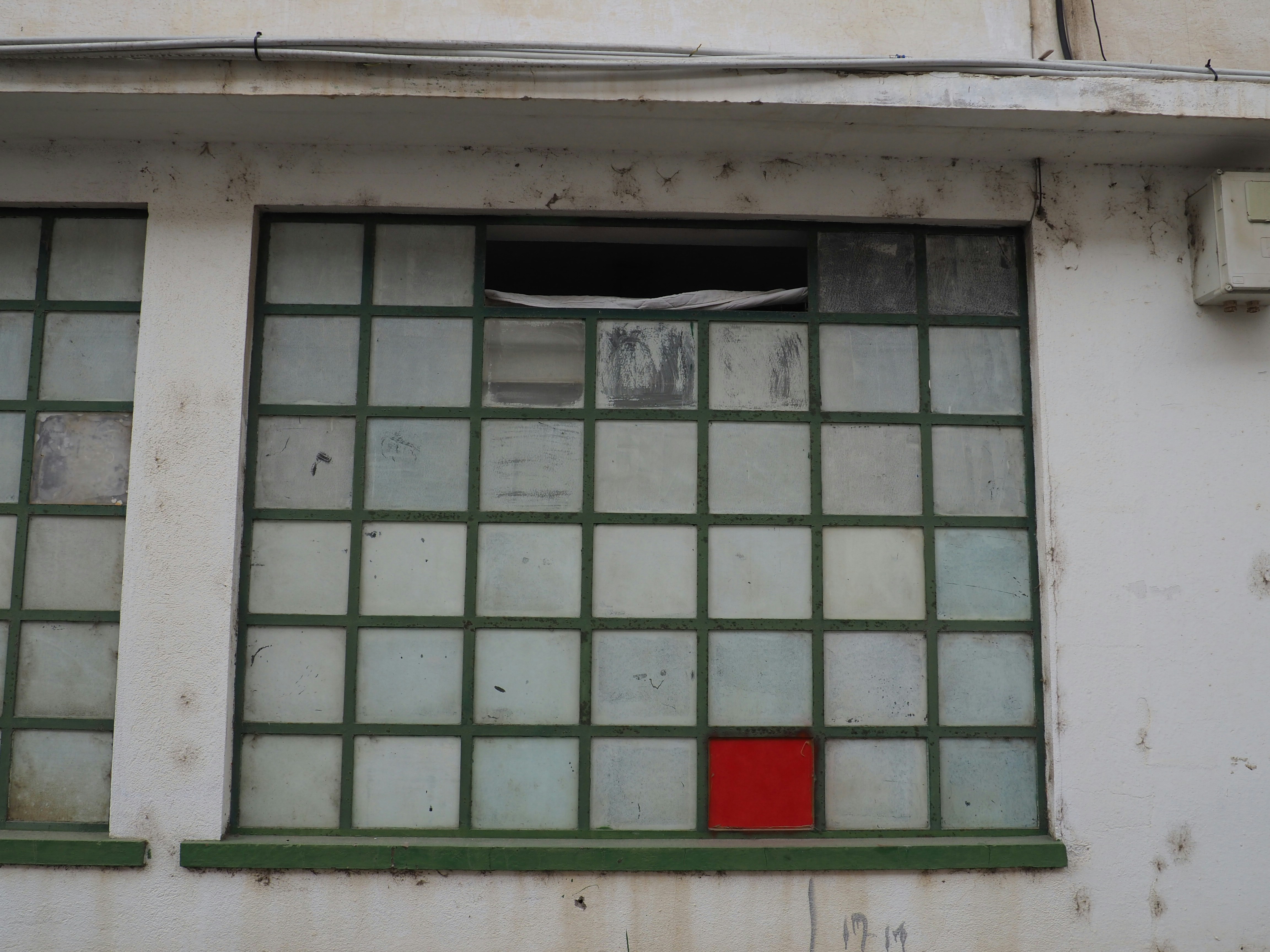 Grid of Quiet Decay: Red Tile as a Silent Accent
