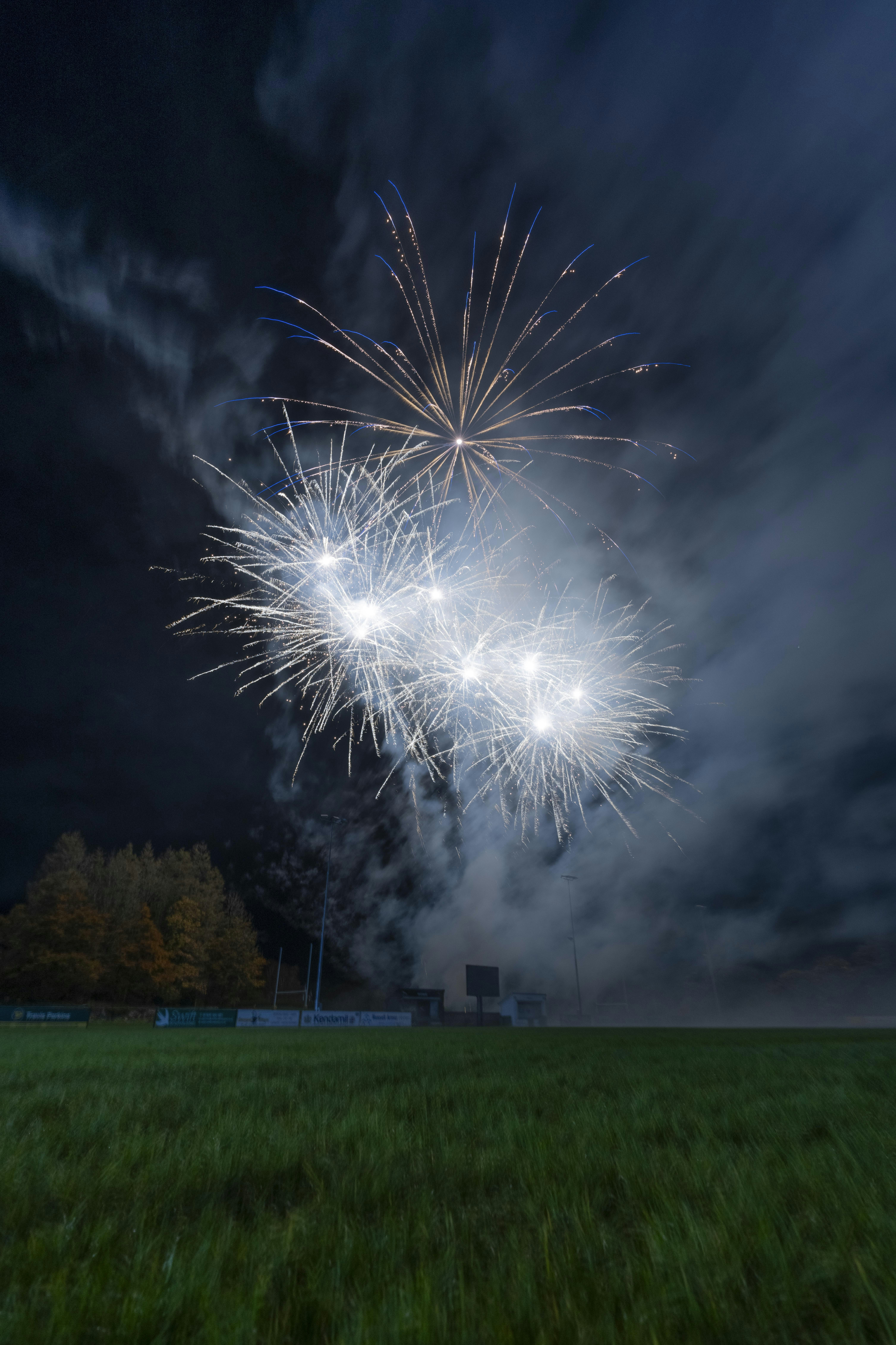 A fireworks display in the night sky over a field photo – Free Kendal ...