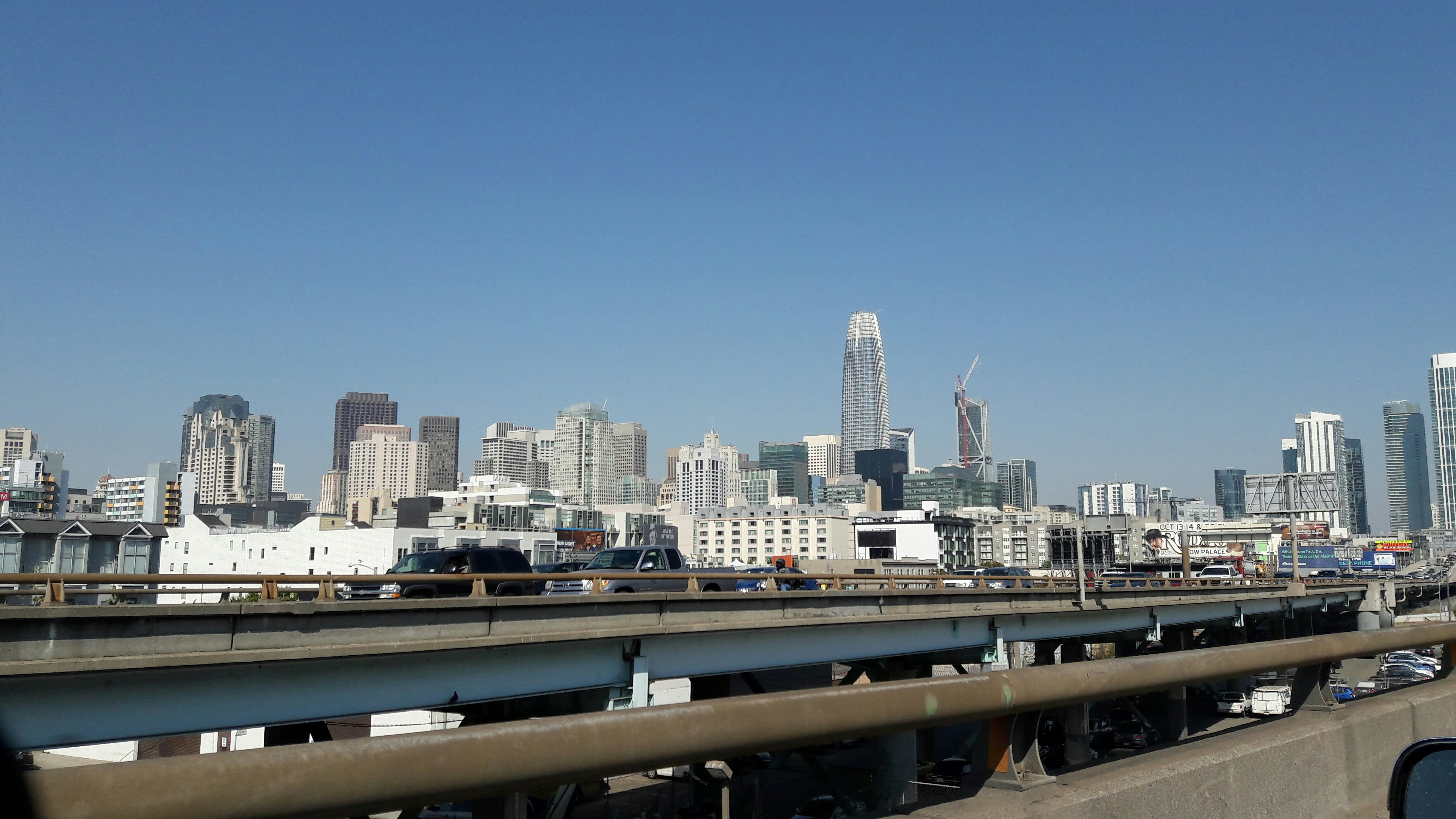 A freeway with a lot of traffic and tall buildings in the background ...