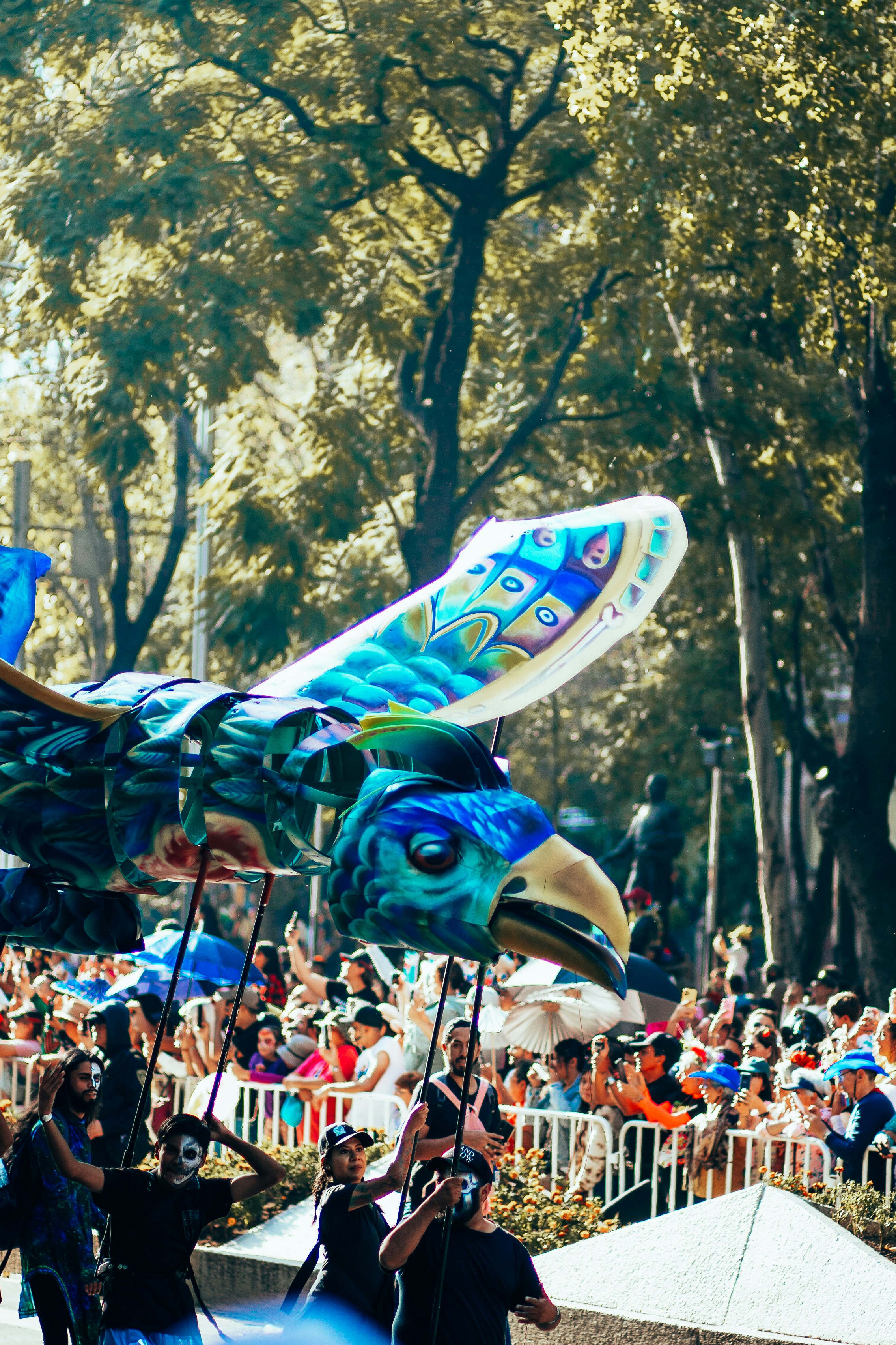 Colorful Mythic Bird Floats Above a Crowded Parade