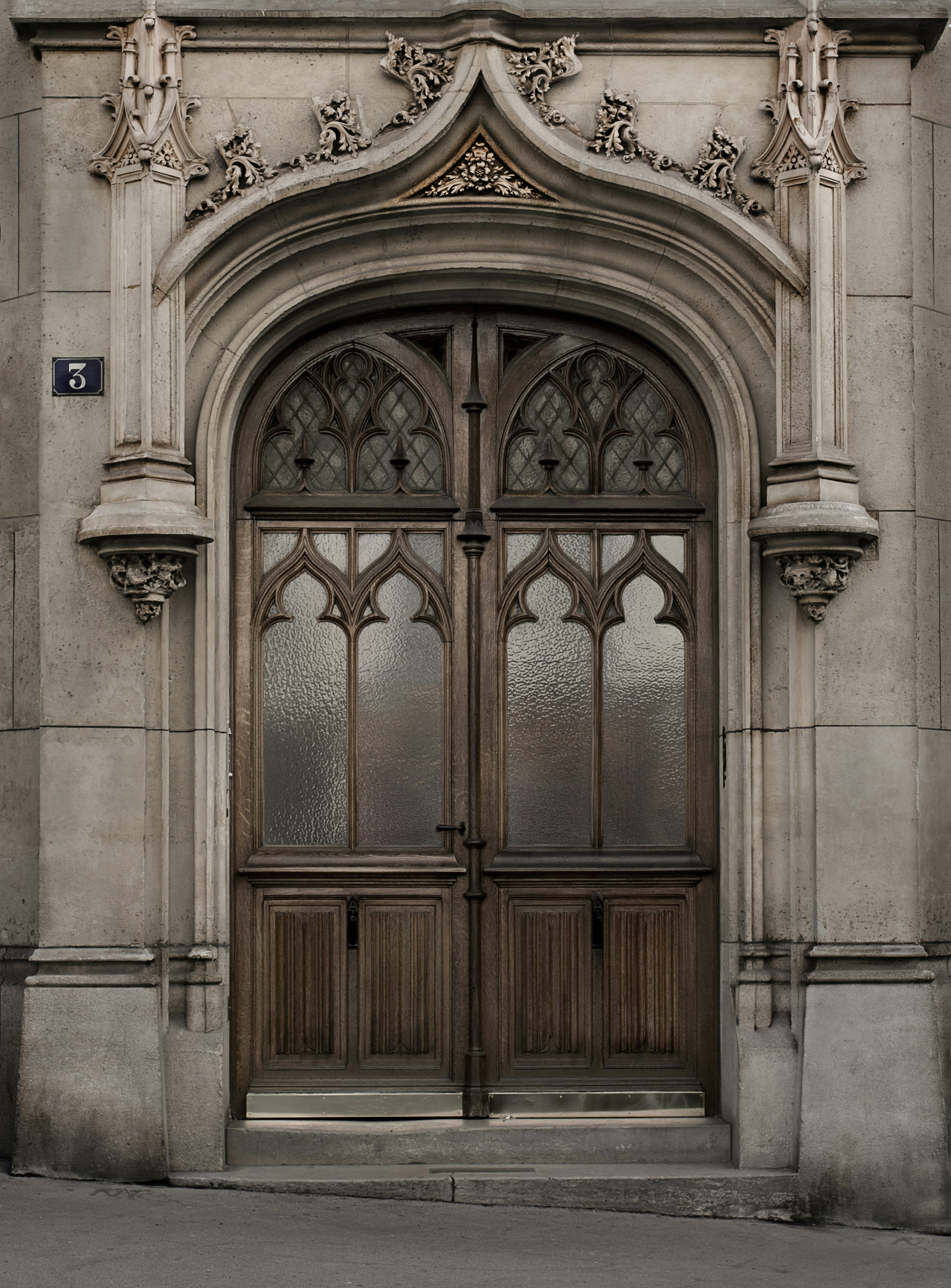 A large stone building with a large wooden door photo – Free Paris Image on Unsplash