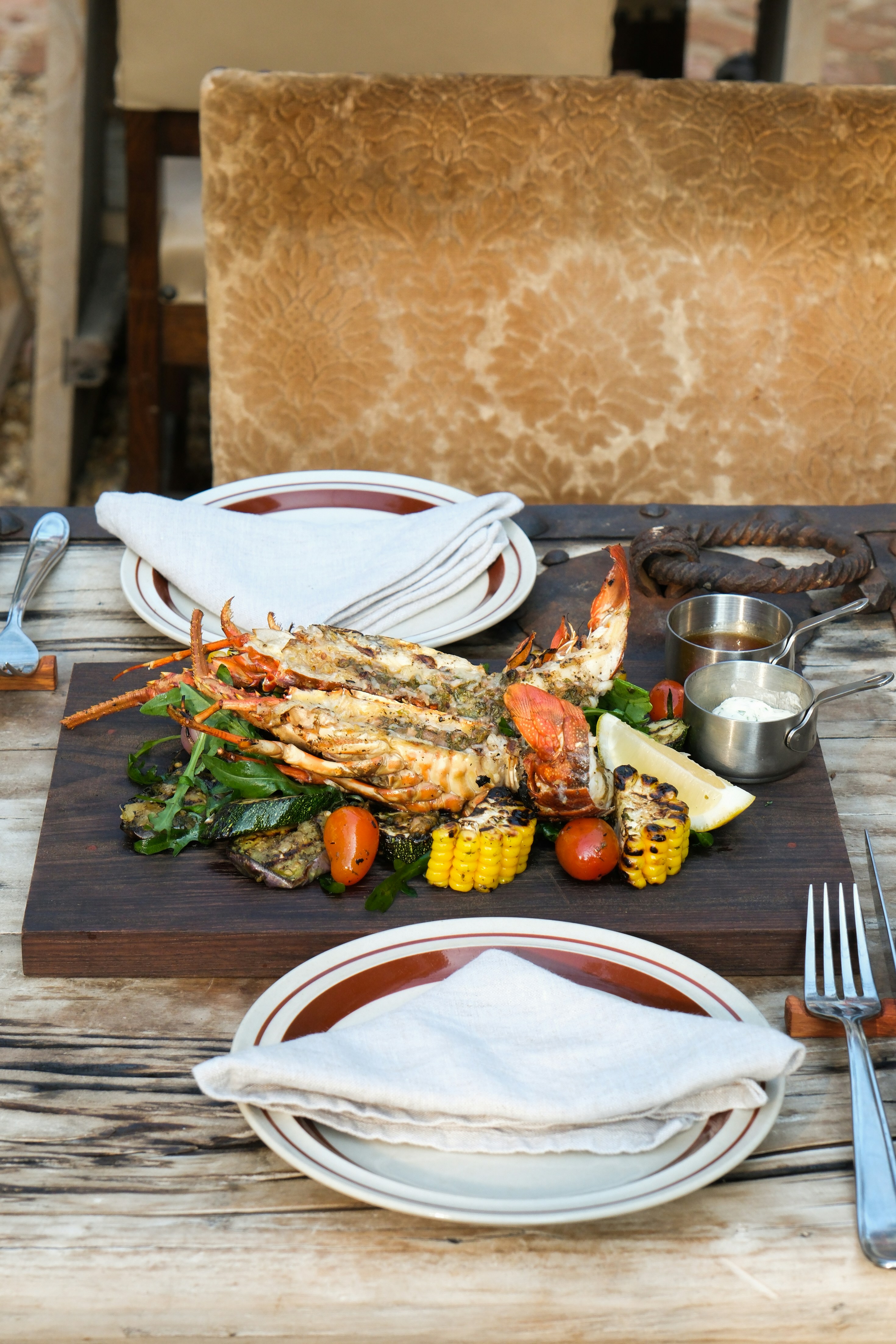 Charred Seafood Medley on a Rustic Wood Board, with Corn and Lemon