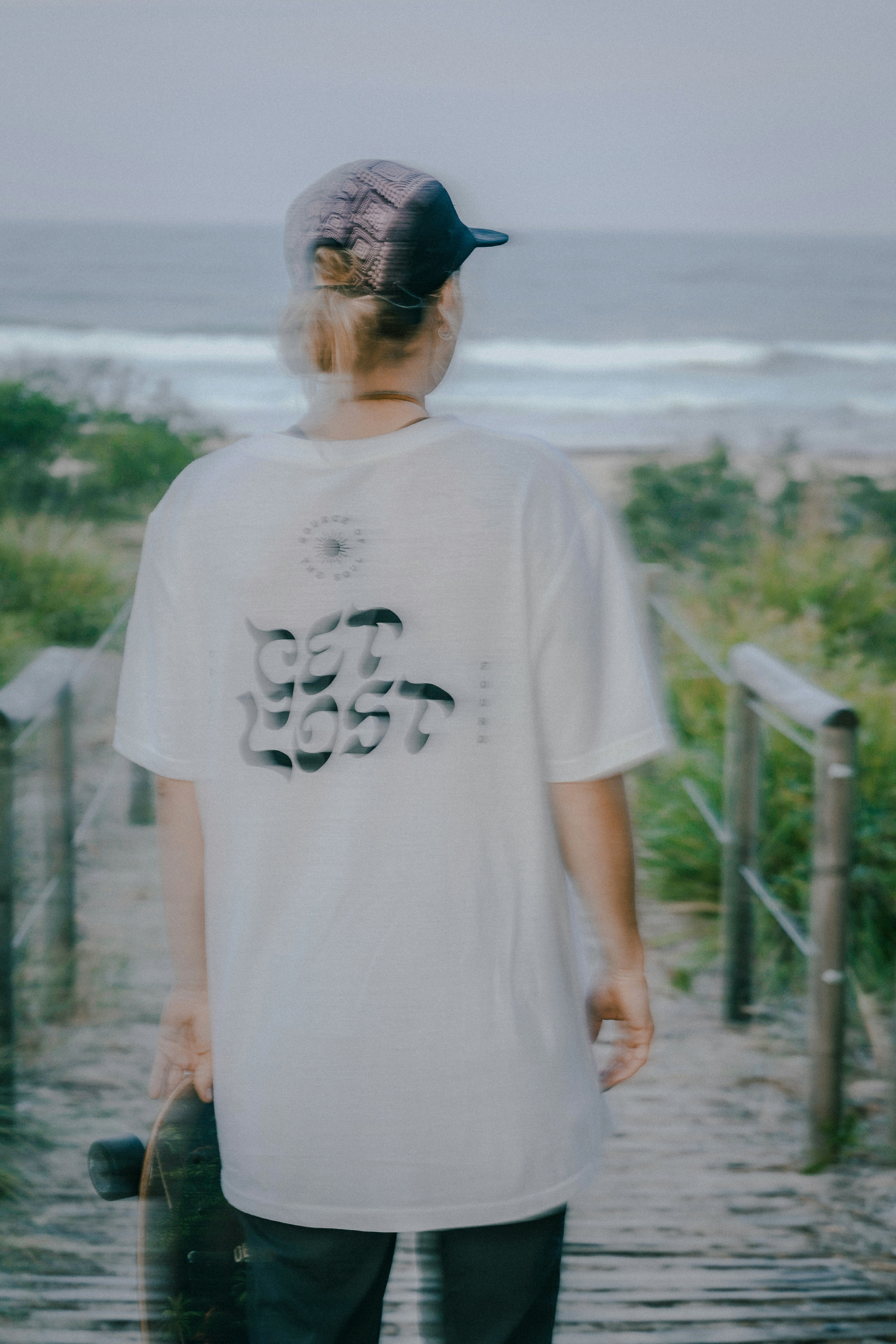 Skater girl with Old Youth 'Get Lost Hemp T-shirt at beach