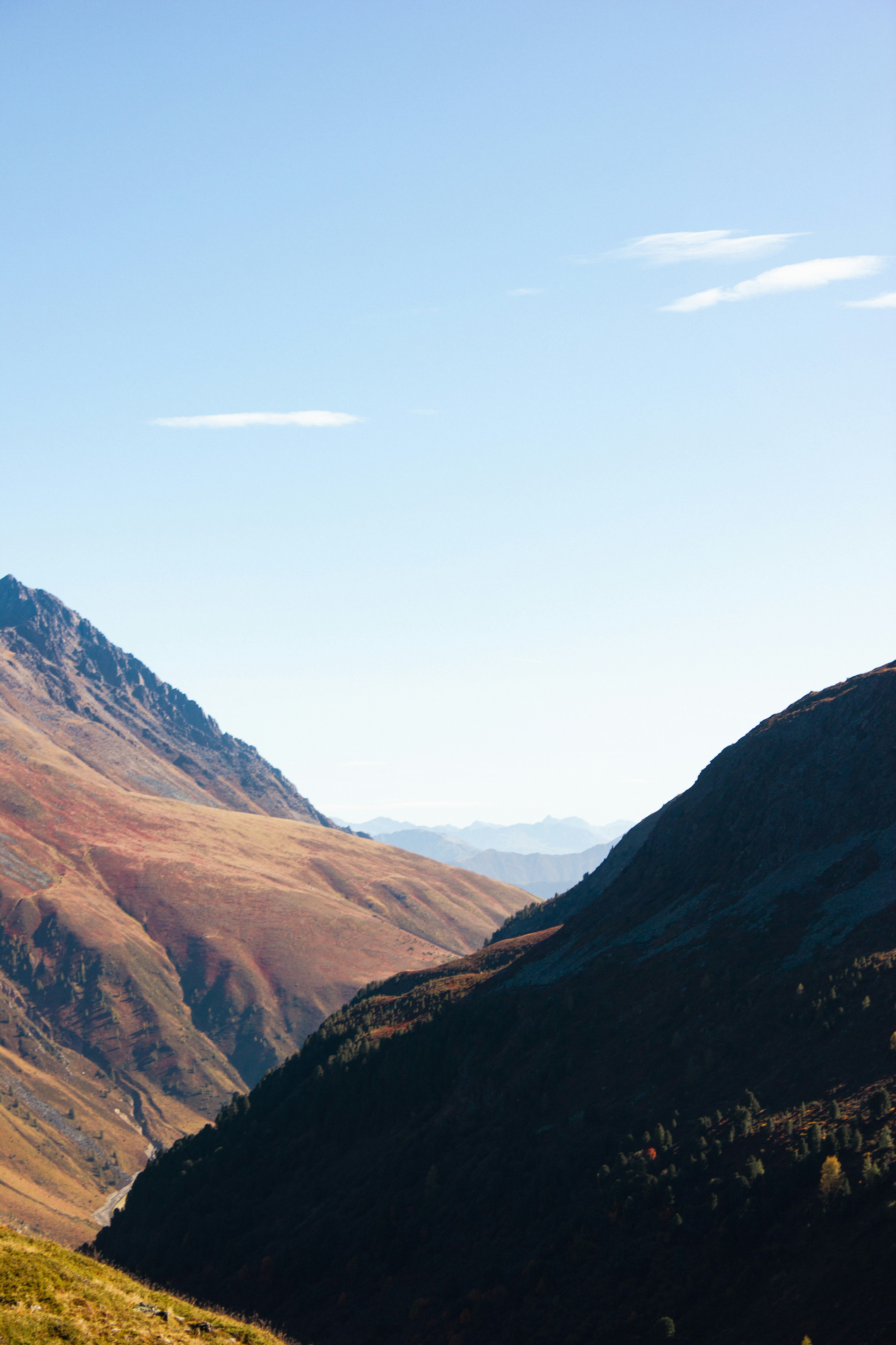 A view of a valley with mountains in the background photo – Free Blue ...