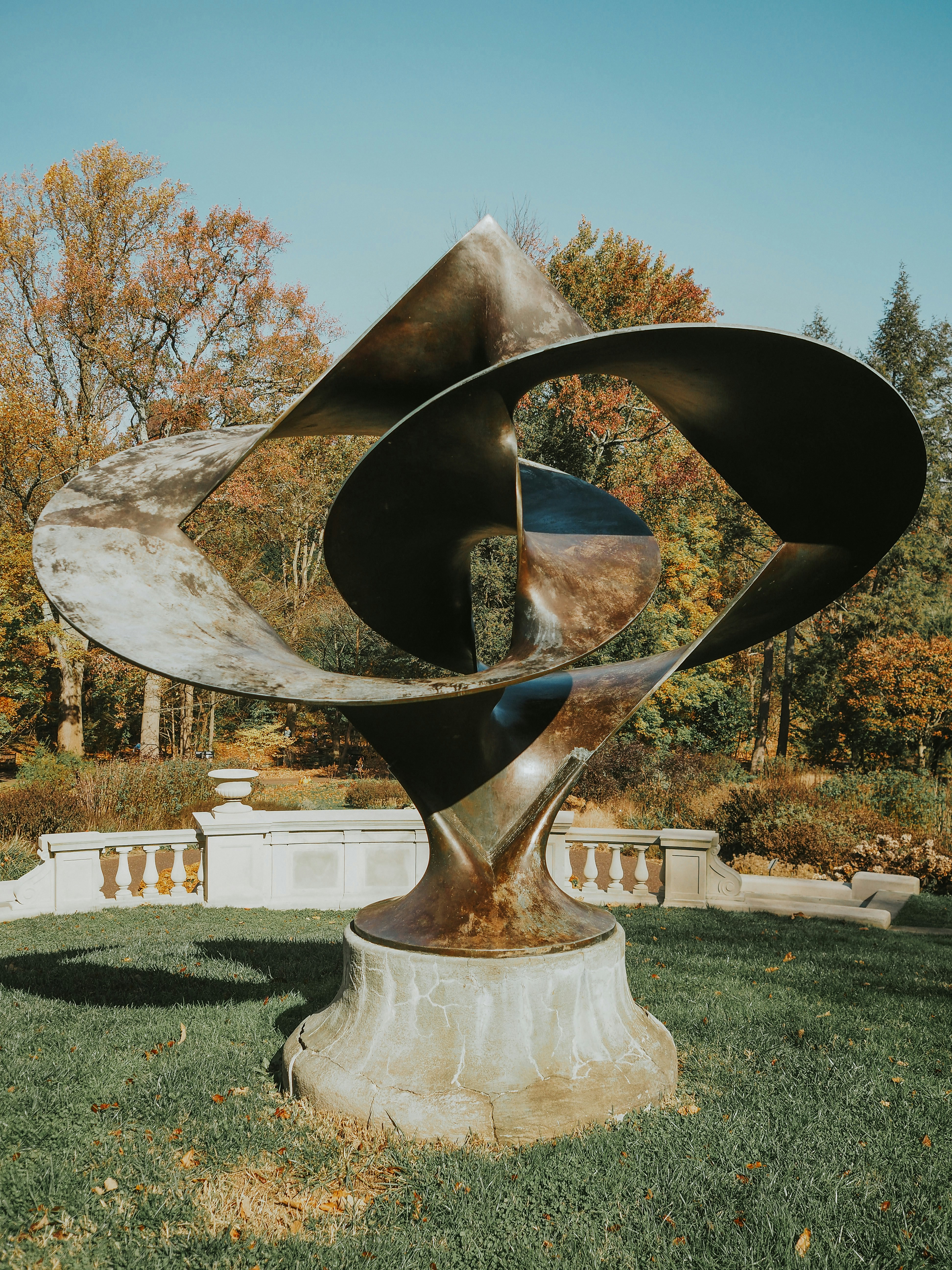 a large metal sculpture in the middle of a park