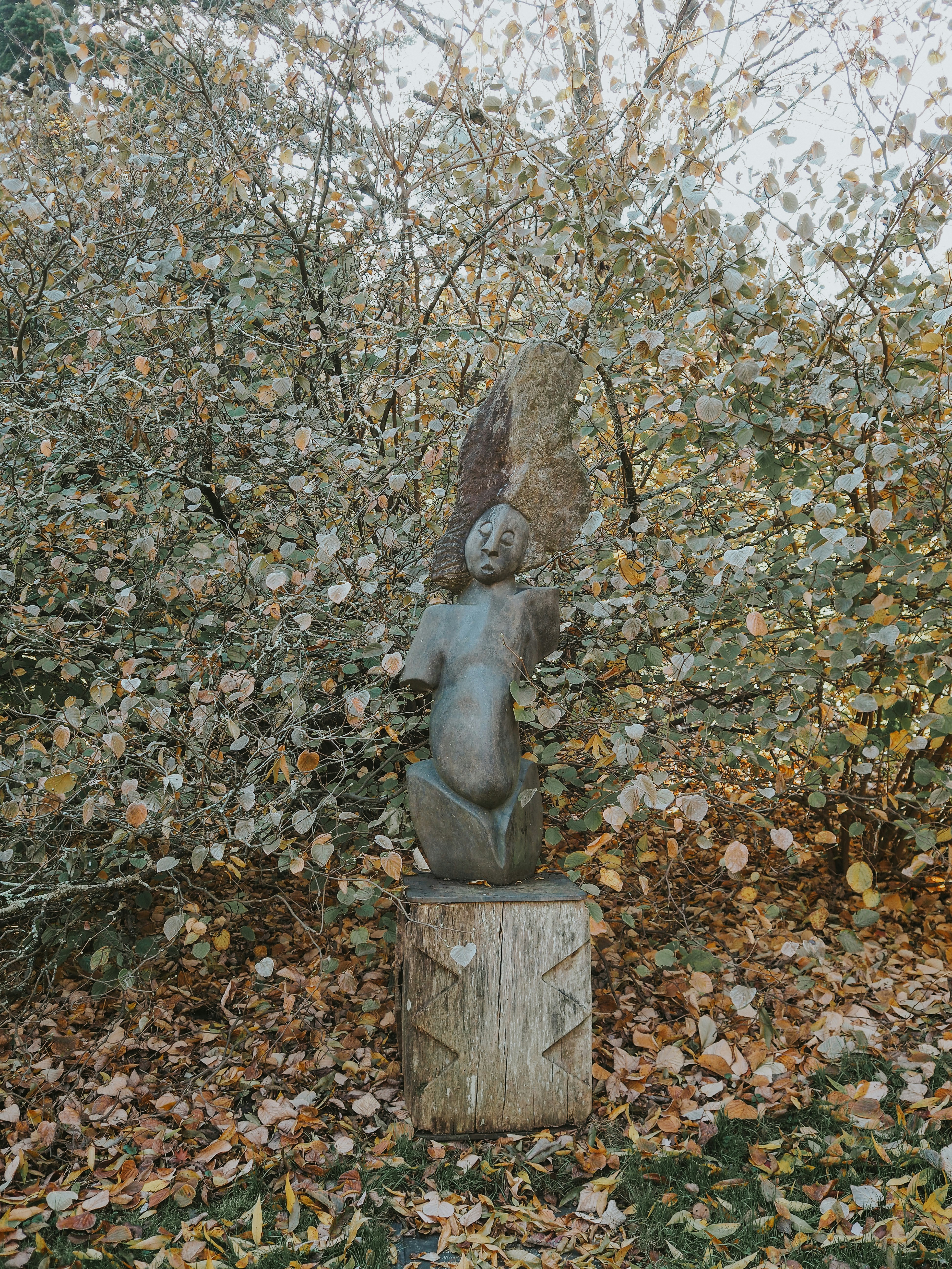 Bronze Sentinel Amid Autumn's Leafy Veil