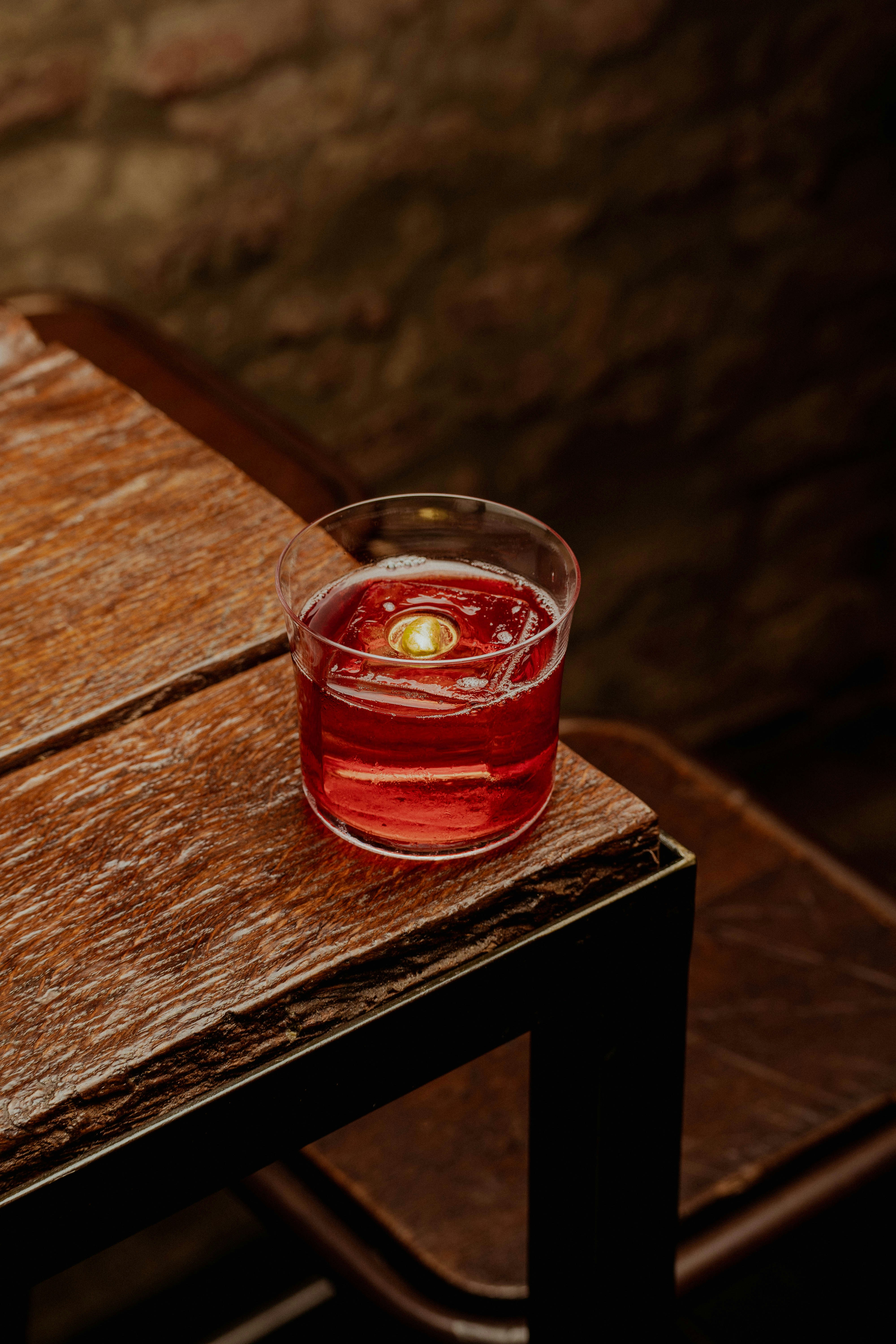 Crimson Elixir on Weathered Wood