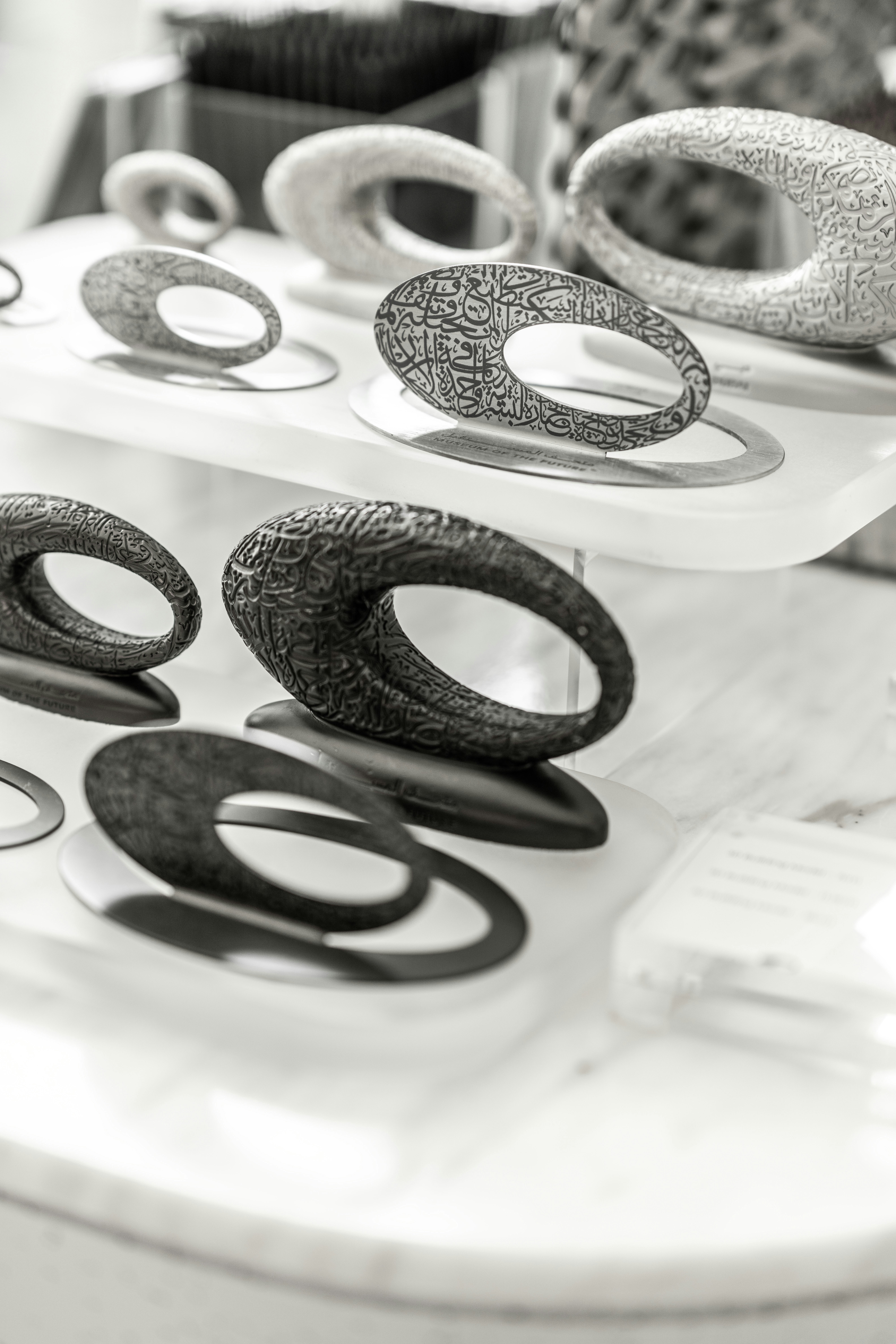 Looped Geometry: Etched bracelets on a glossy display