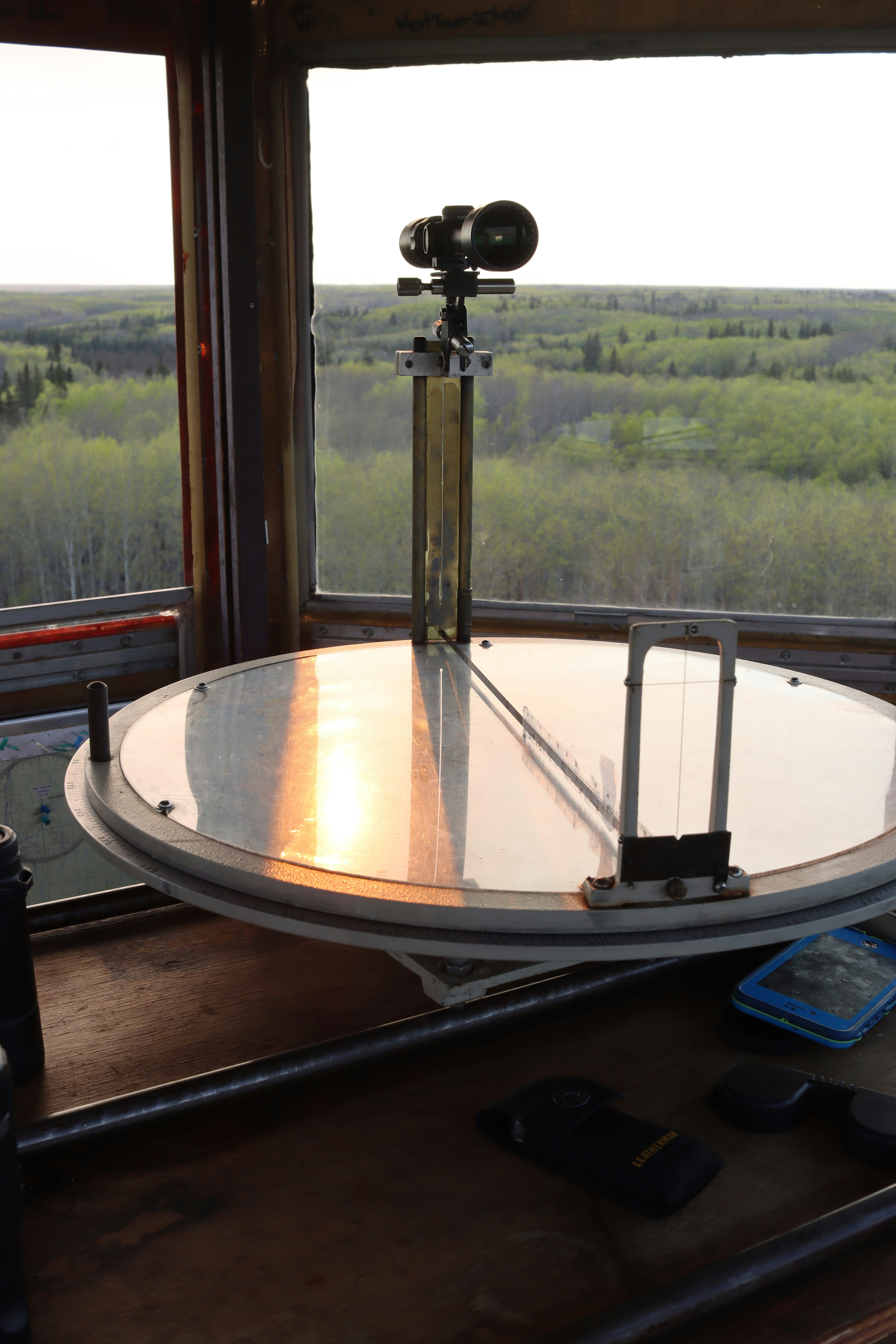 A satellite dish sitting on top of a table next to a window photo ...
