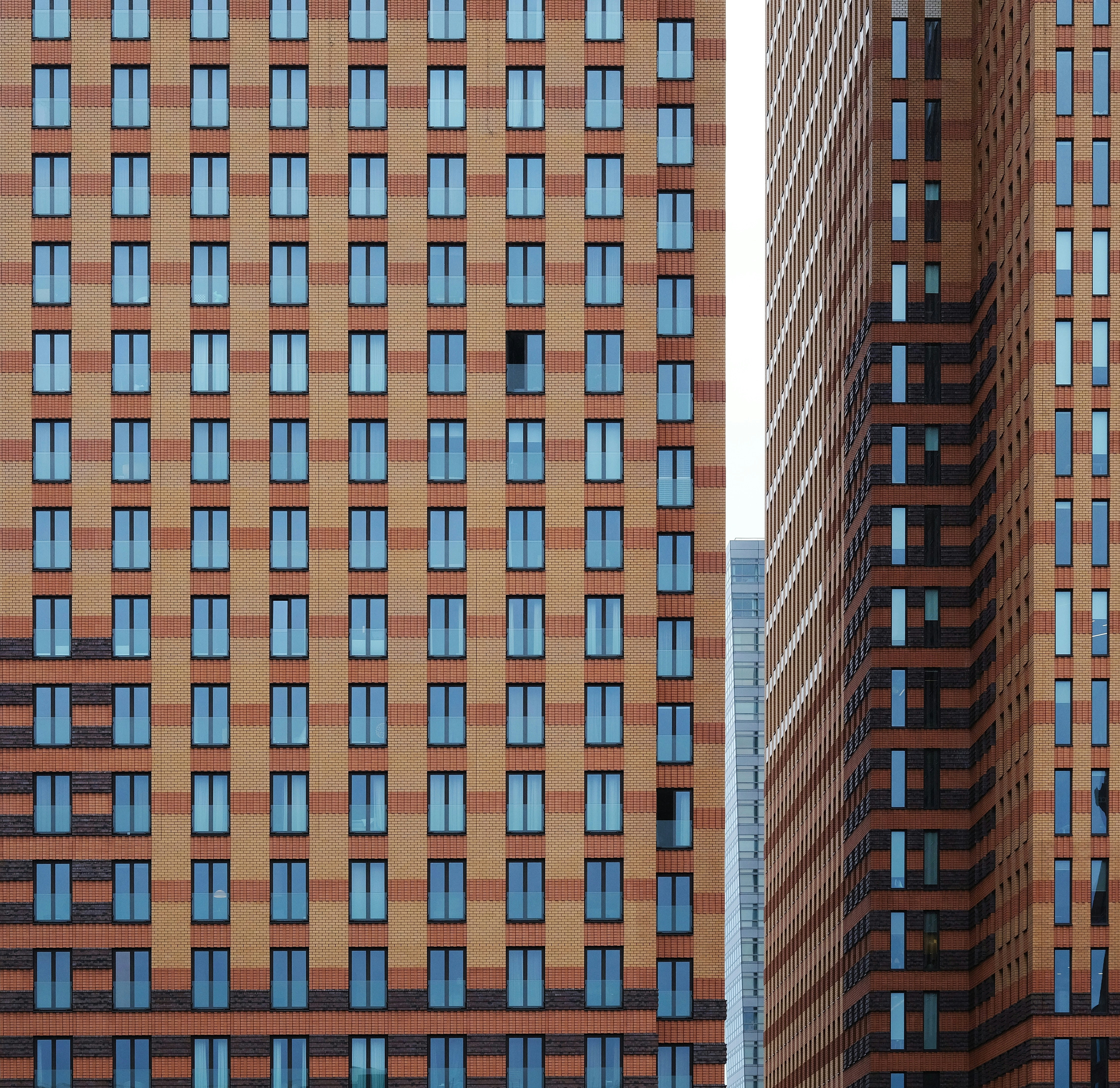 A tall building with many windows next to each other photo – Free ...