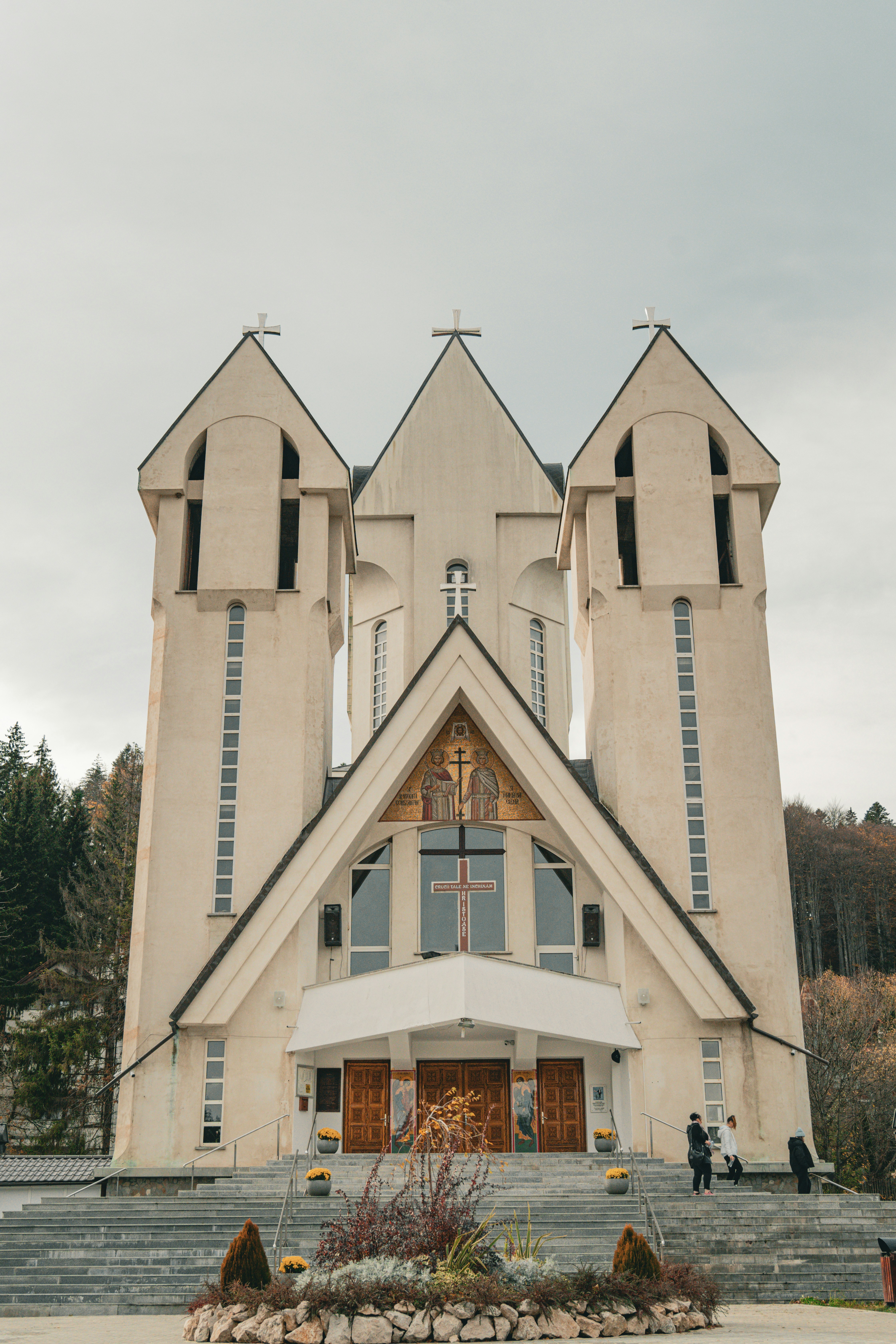 Triad of Spires: A Concrete Church Framed by Steps and Cross