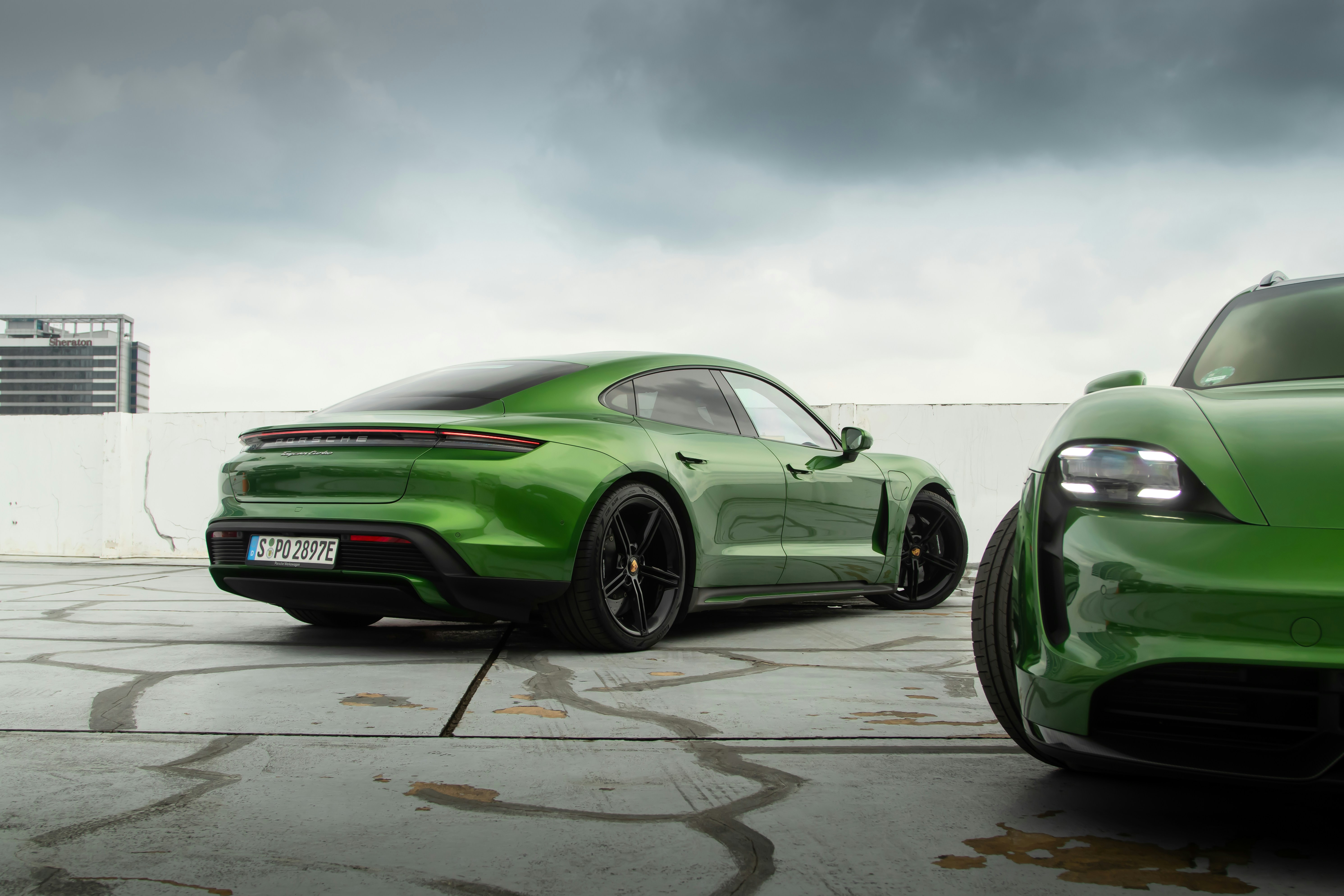 A pair of green sports cars parked next to each other photo – Free ...