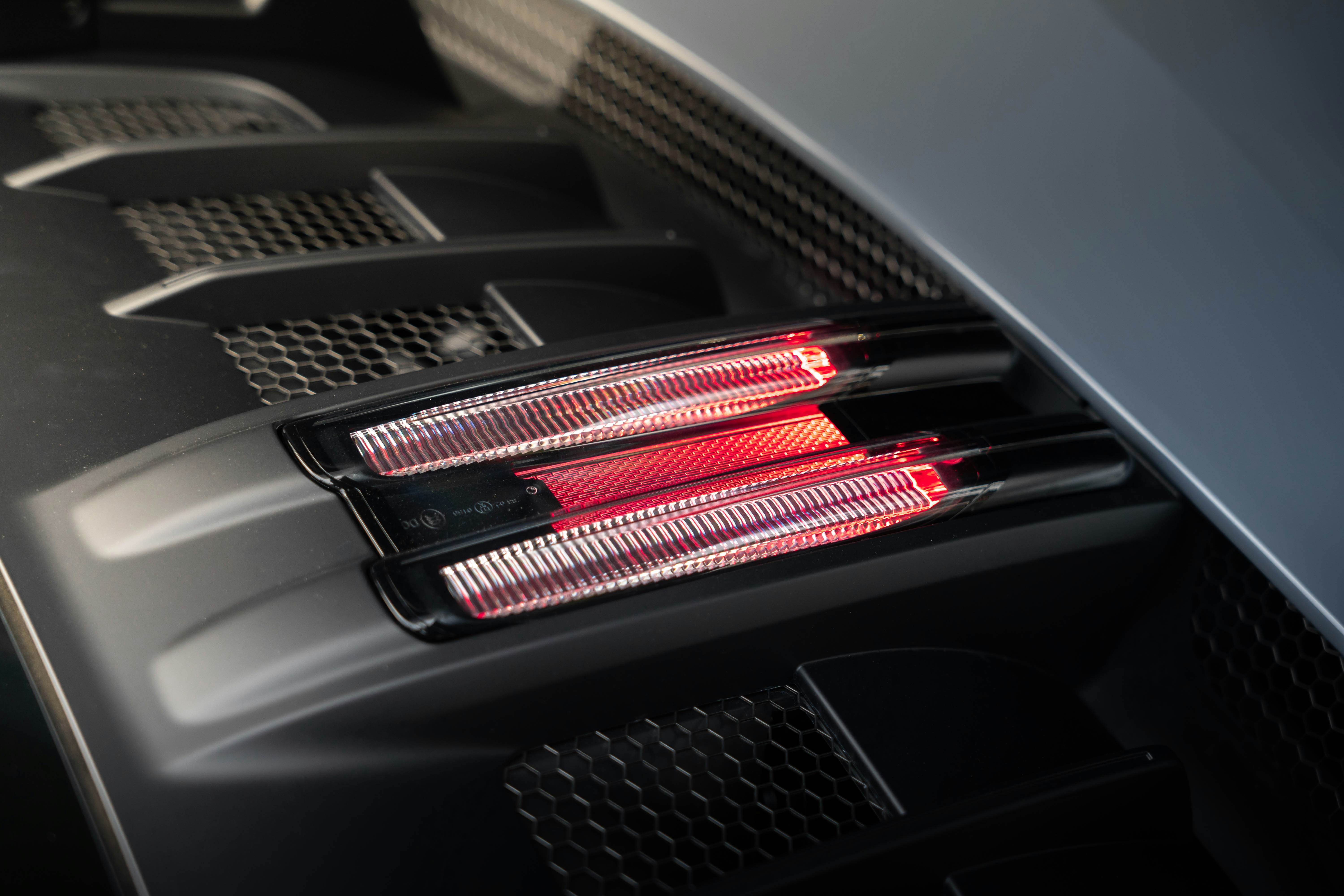 Red Backlit Vents: Precision Mesh and Carbon Silhouette