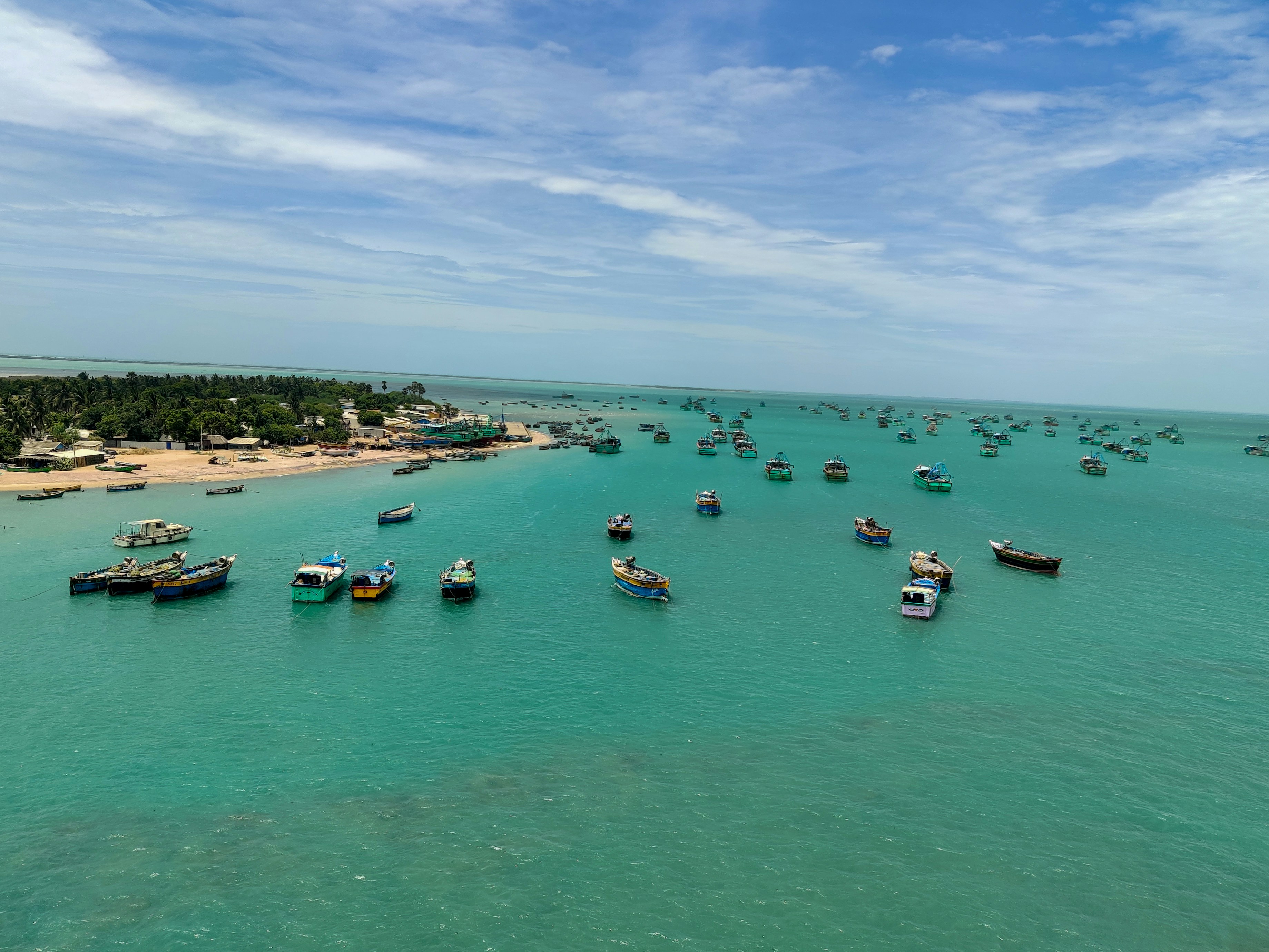 Harbor of Turquoise: A Quiet Fleet Anchored Along a Coral Coast