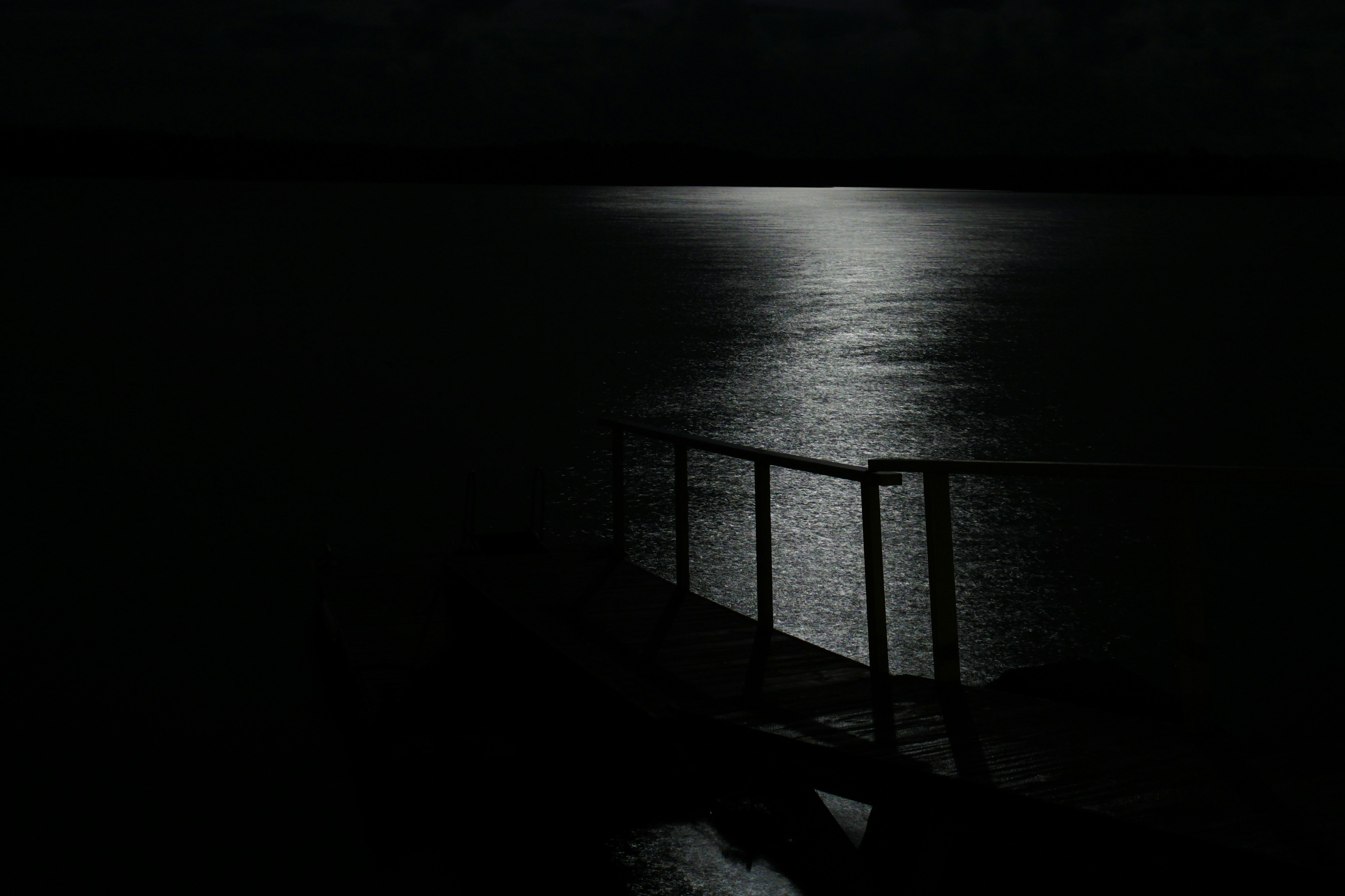 Moon-Silvered Pier: A Night Scene in Quiet Ripples