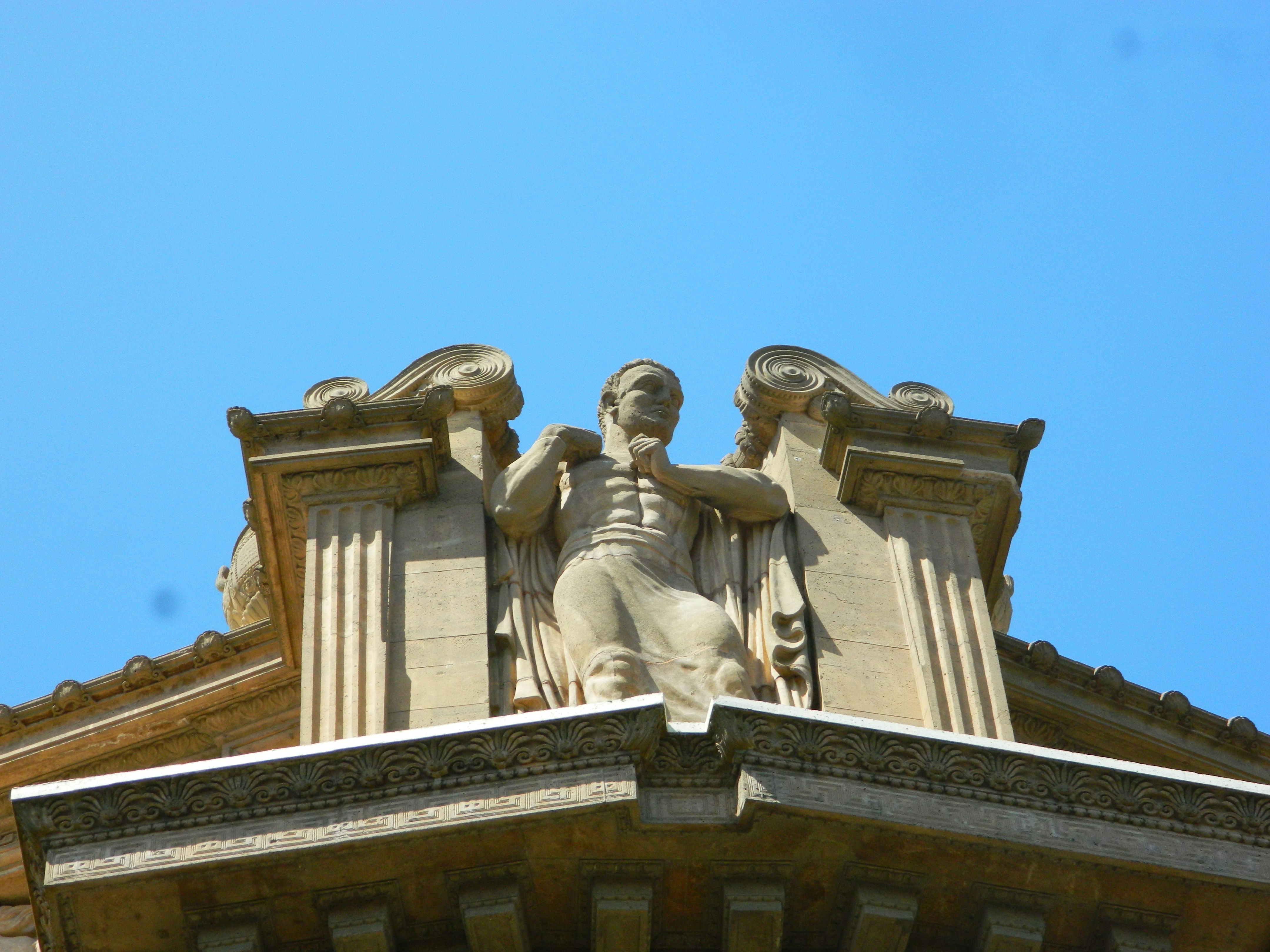 Stone Guardian on a Pediment Against a Cerulean Sky
