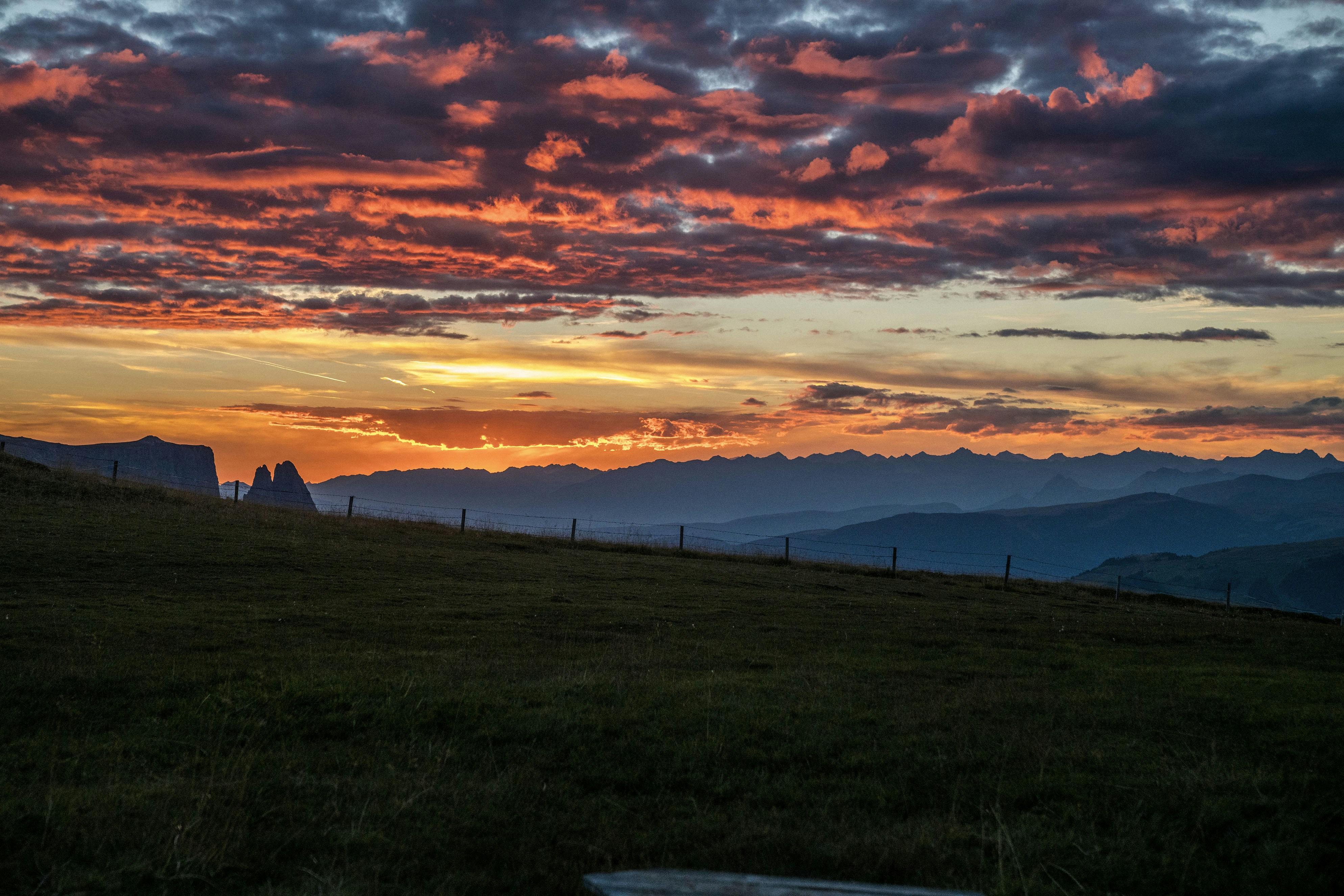 Last Light on the Ridge: Ember Clouds Over a Quiet Valley