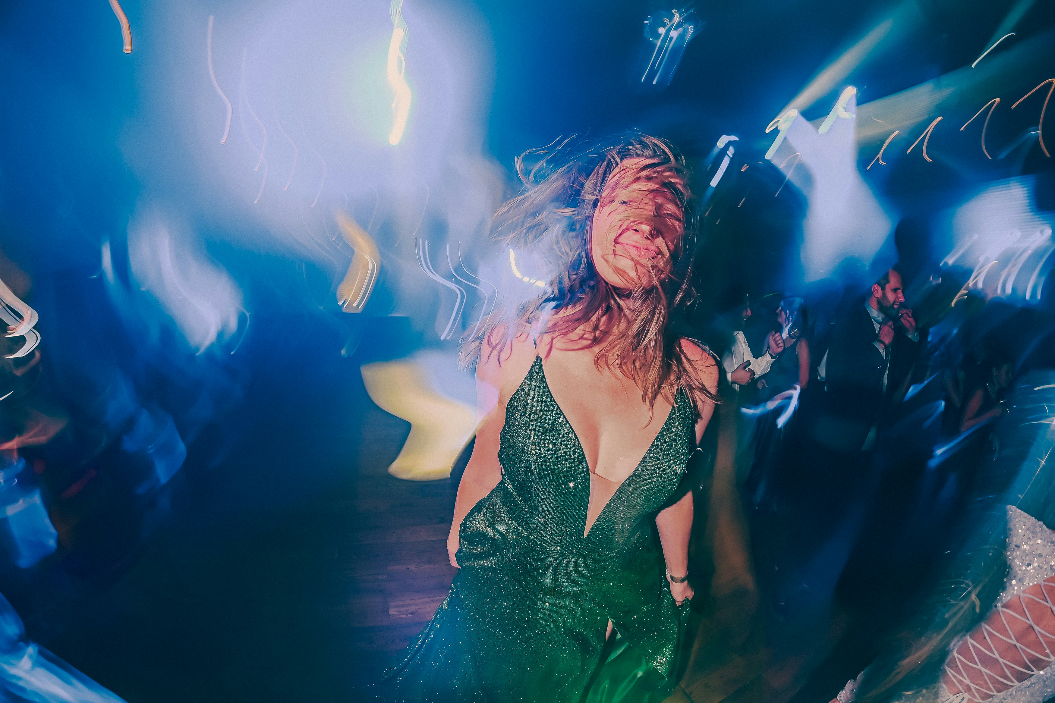 A woman in a green dress dancing at a party photo – Free Lady Image on ...