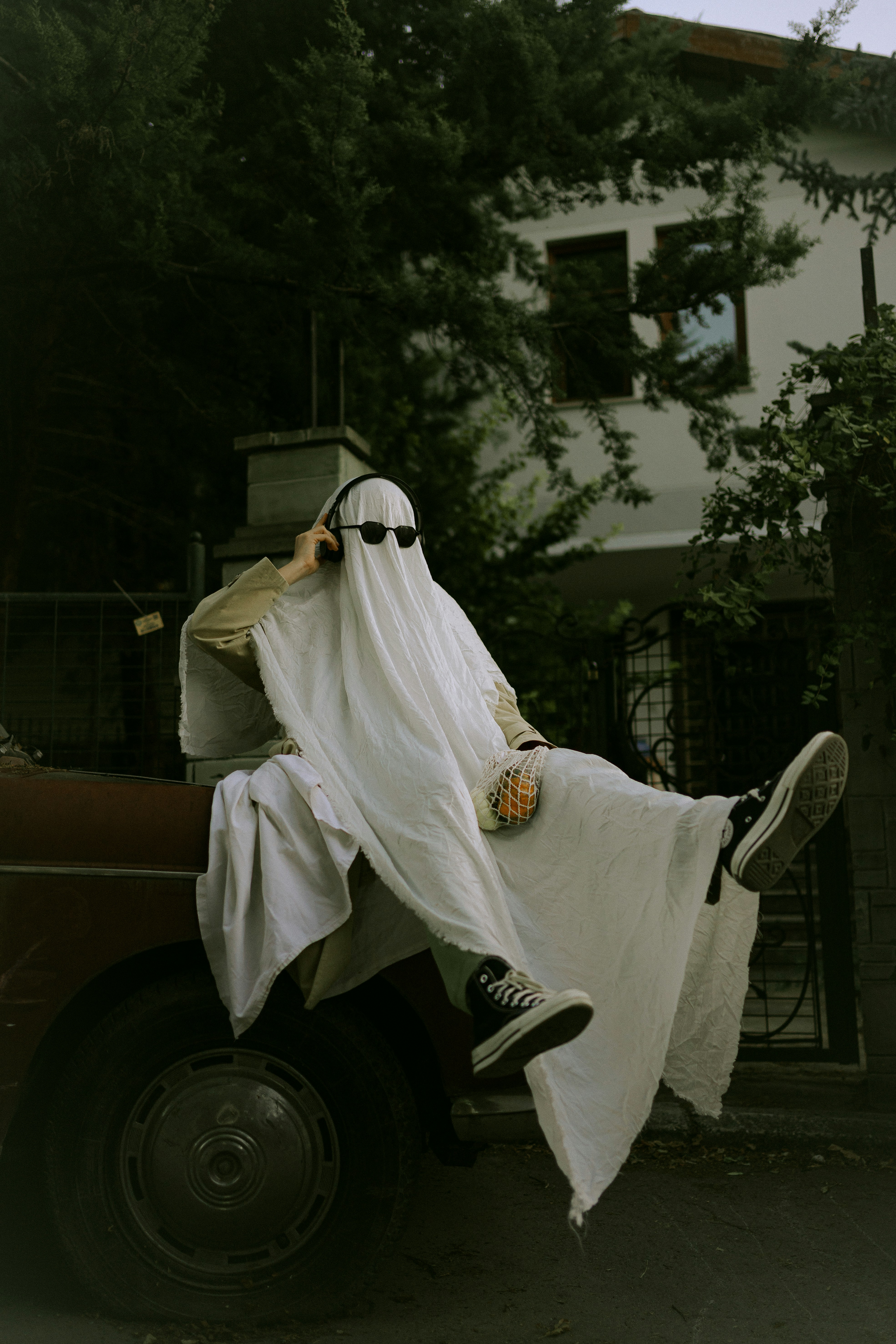 A man dressed as a ghost riding on the back of a truck photo – Free Car ...