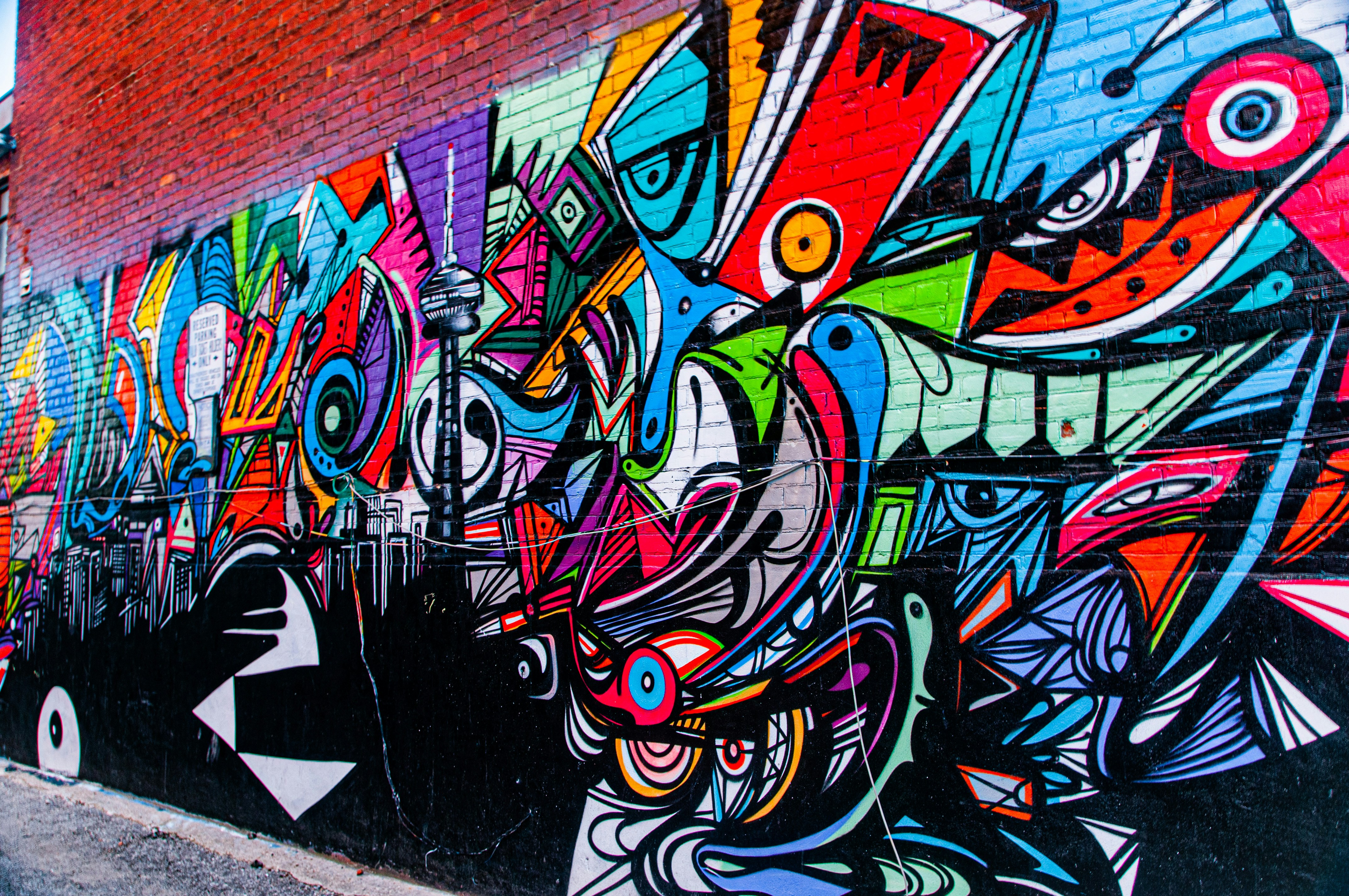 A wall with a bunch of colorful graffiti on it photo – Free Art Image ...