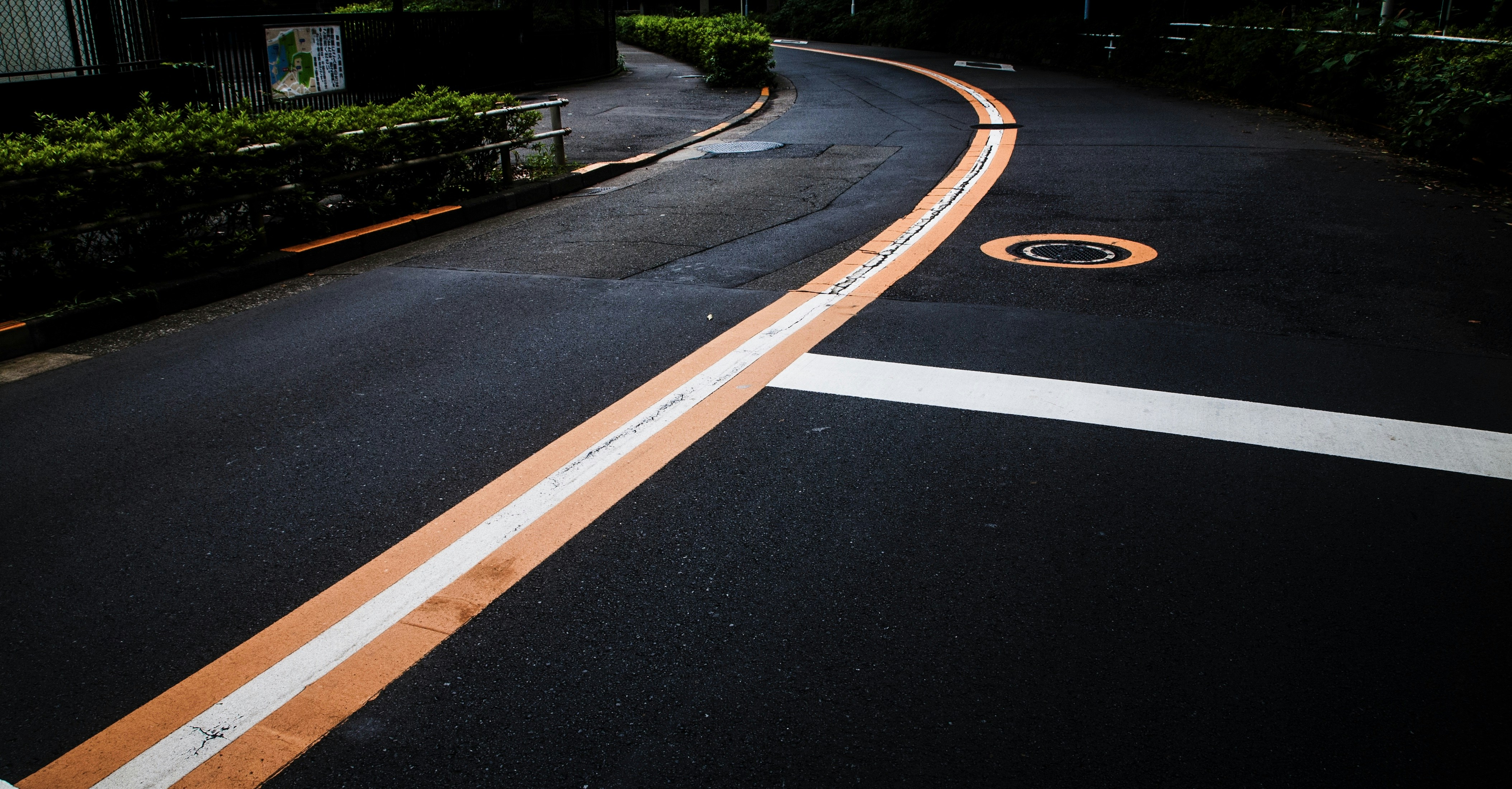 A curved road with a stop sign on the side of it photo – Free Road ...