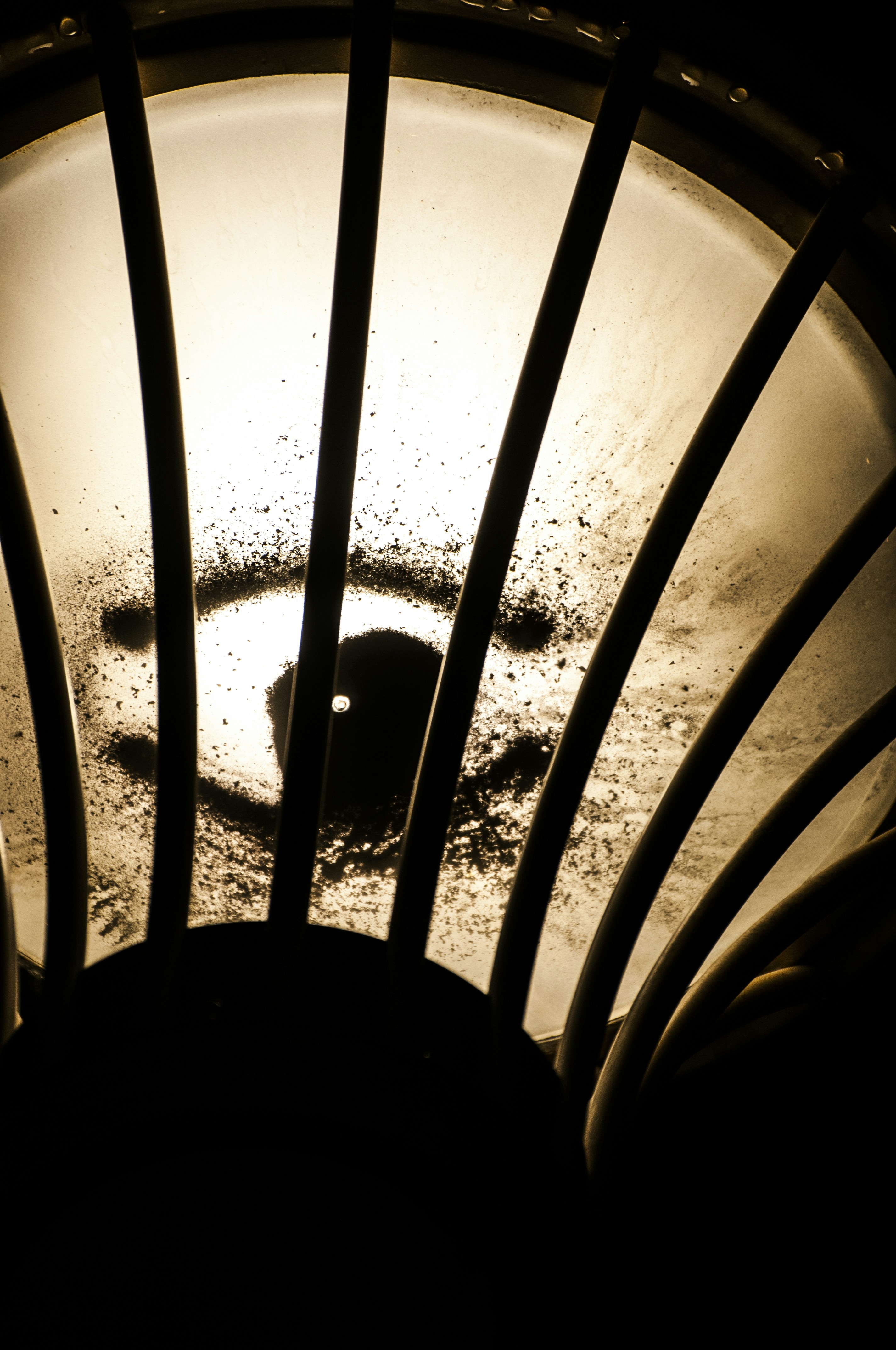 Backlit Halo: A Circular Vent Behind Vertical Rails