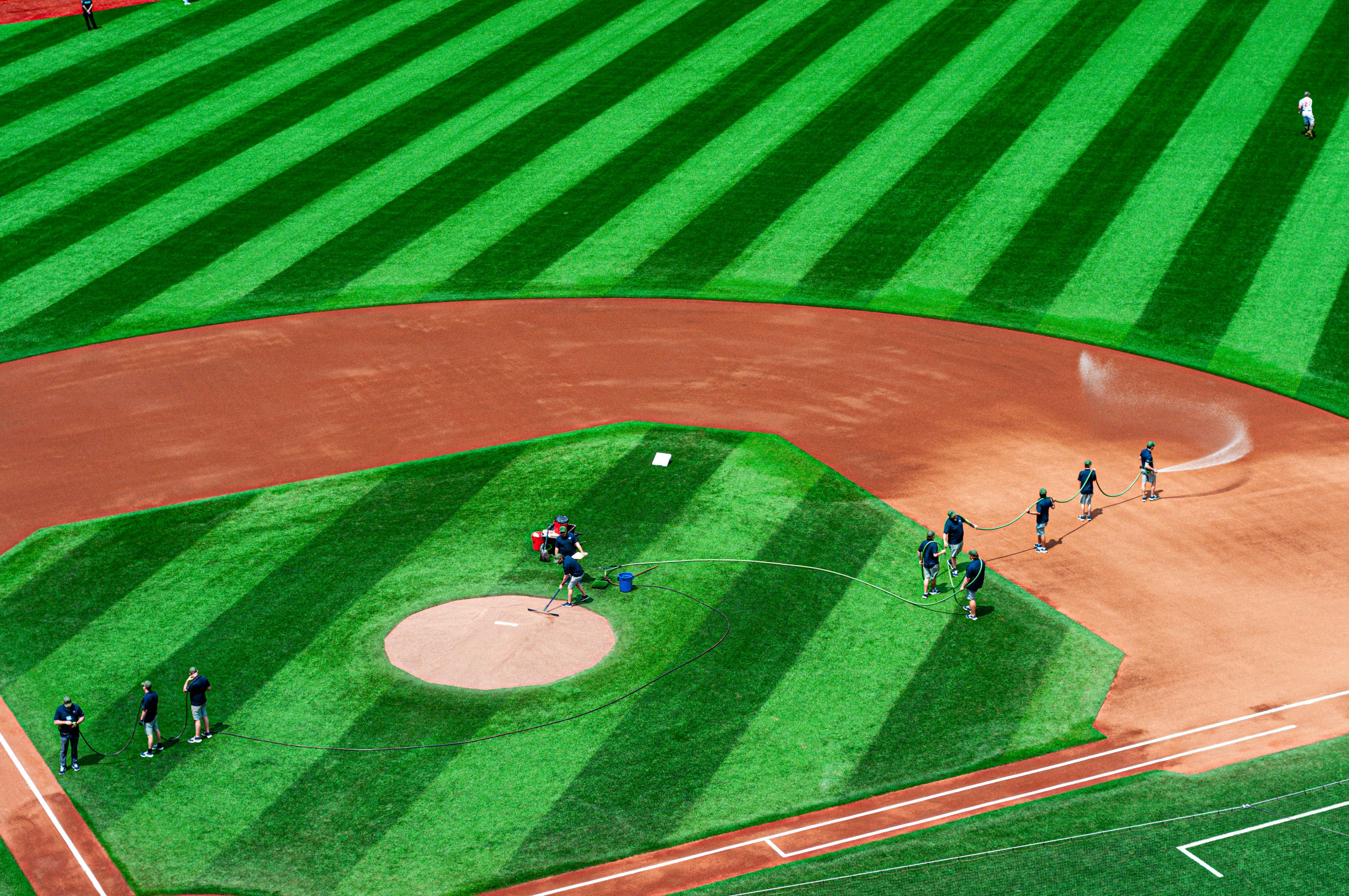 A baseball field with a pitcher throwing a ball photo – Free Human ...
