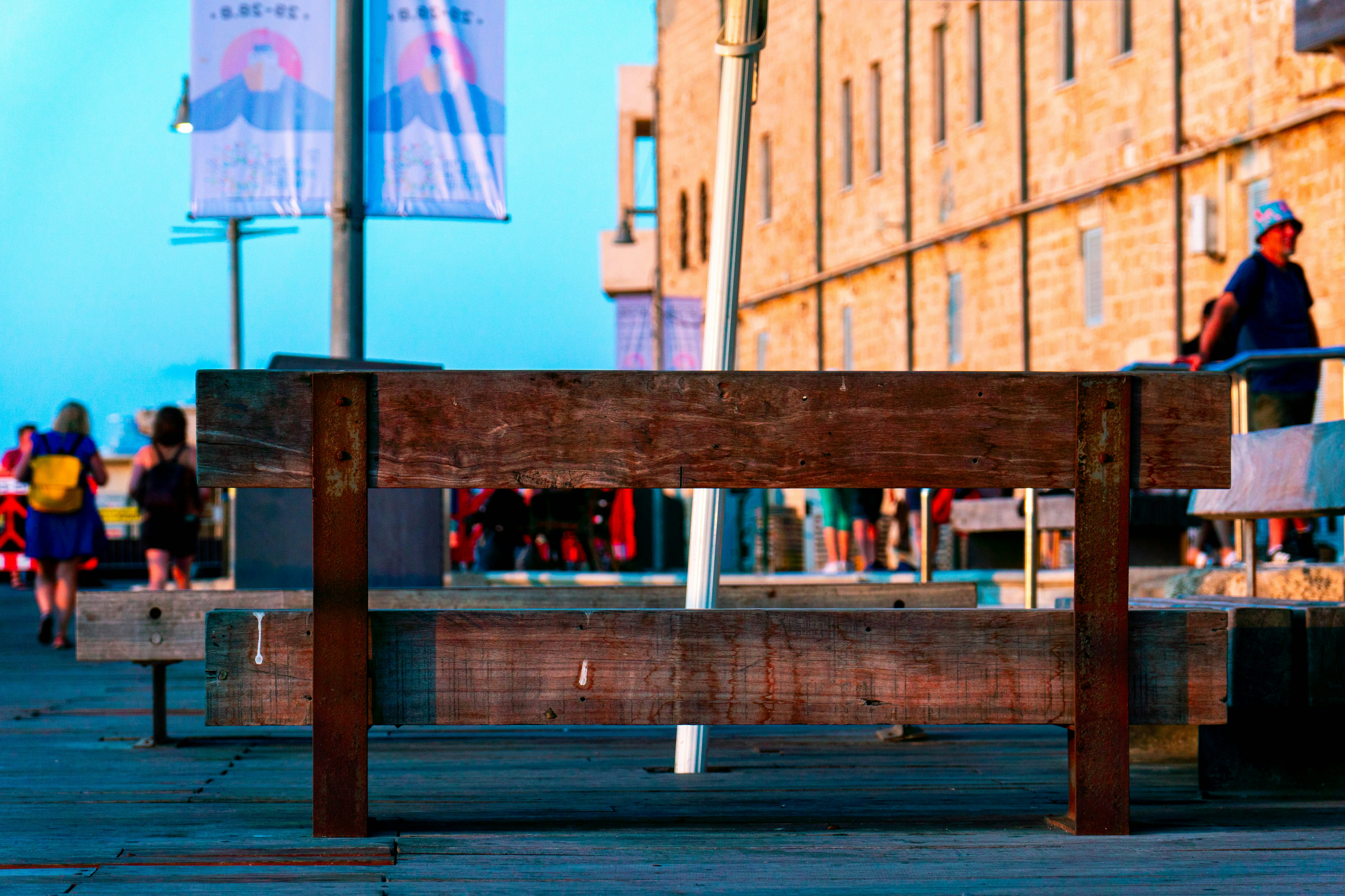 Blue-hour Bench on a Brick Promenade: Quiet Focus Amid City Motion