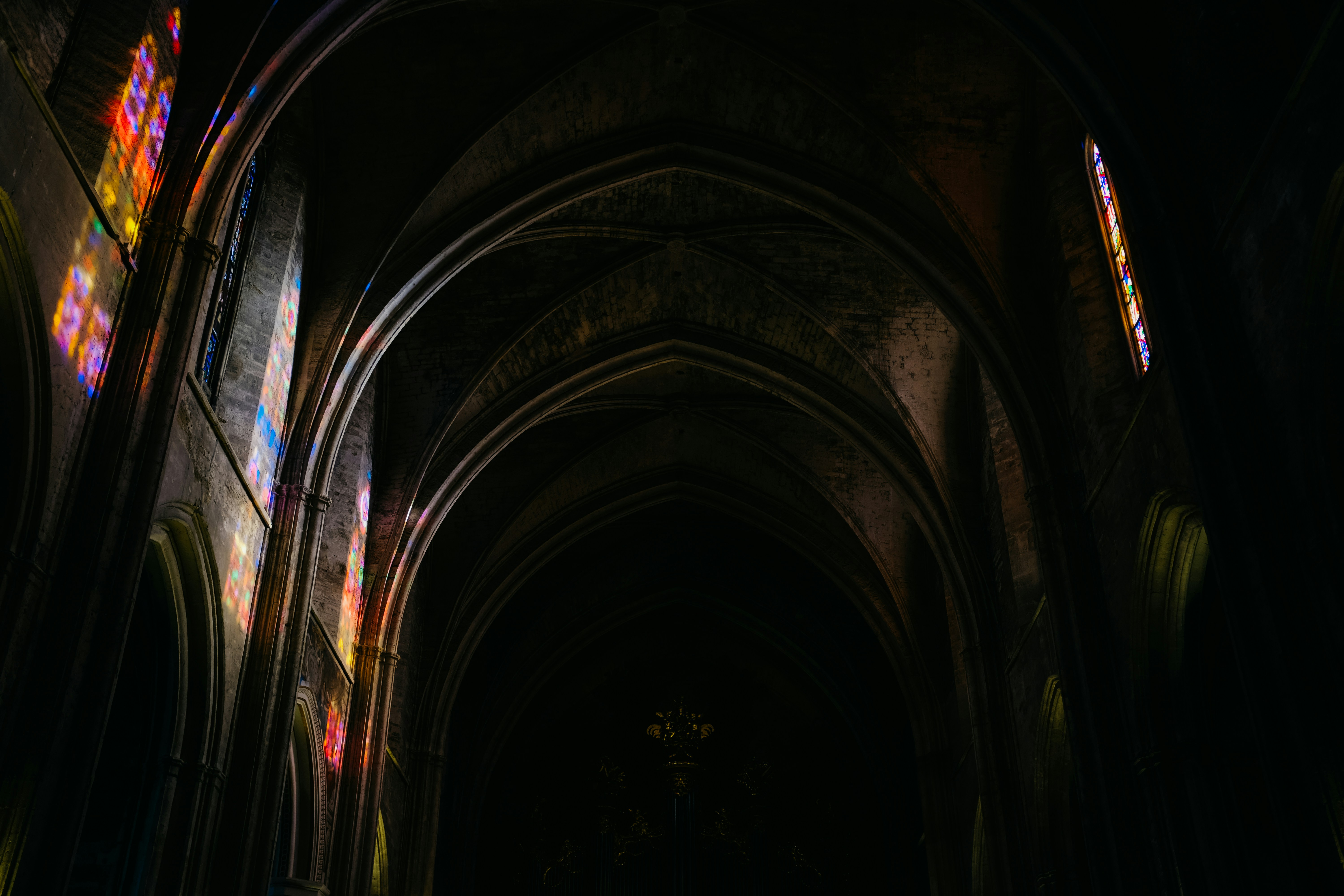 A dimly lit cathedral with stained glass windows photo – Free Building ...