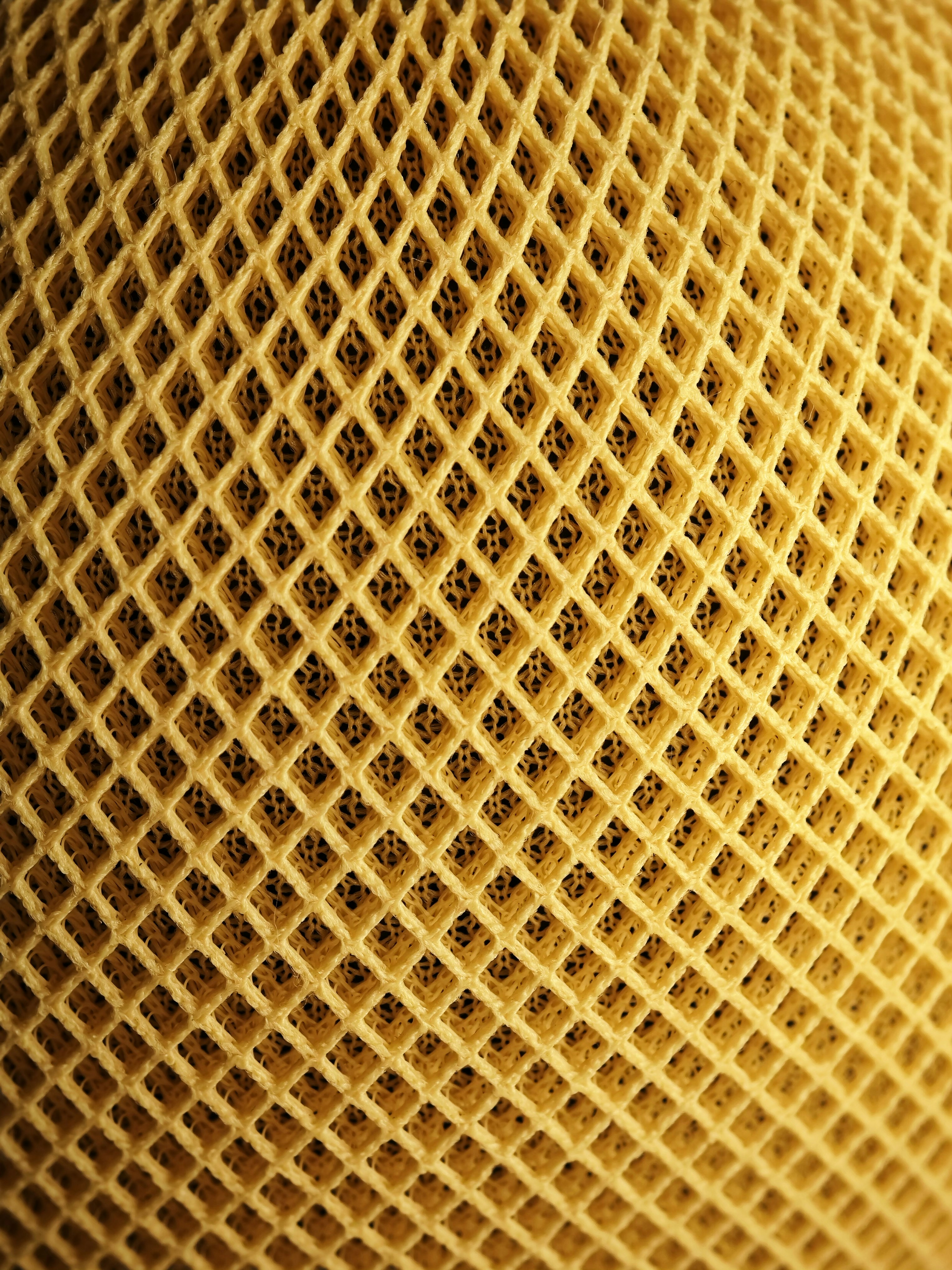 Golden Diamond Mesh: Close-Up on a Cardboard Honeycomb Texture