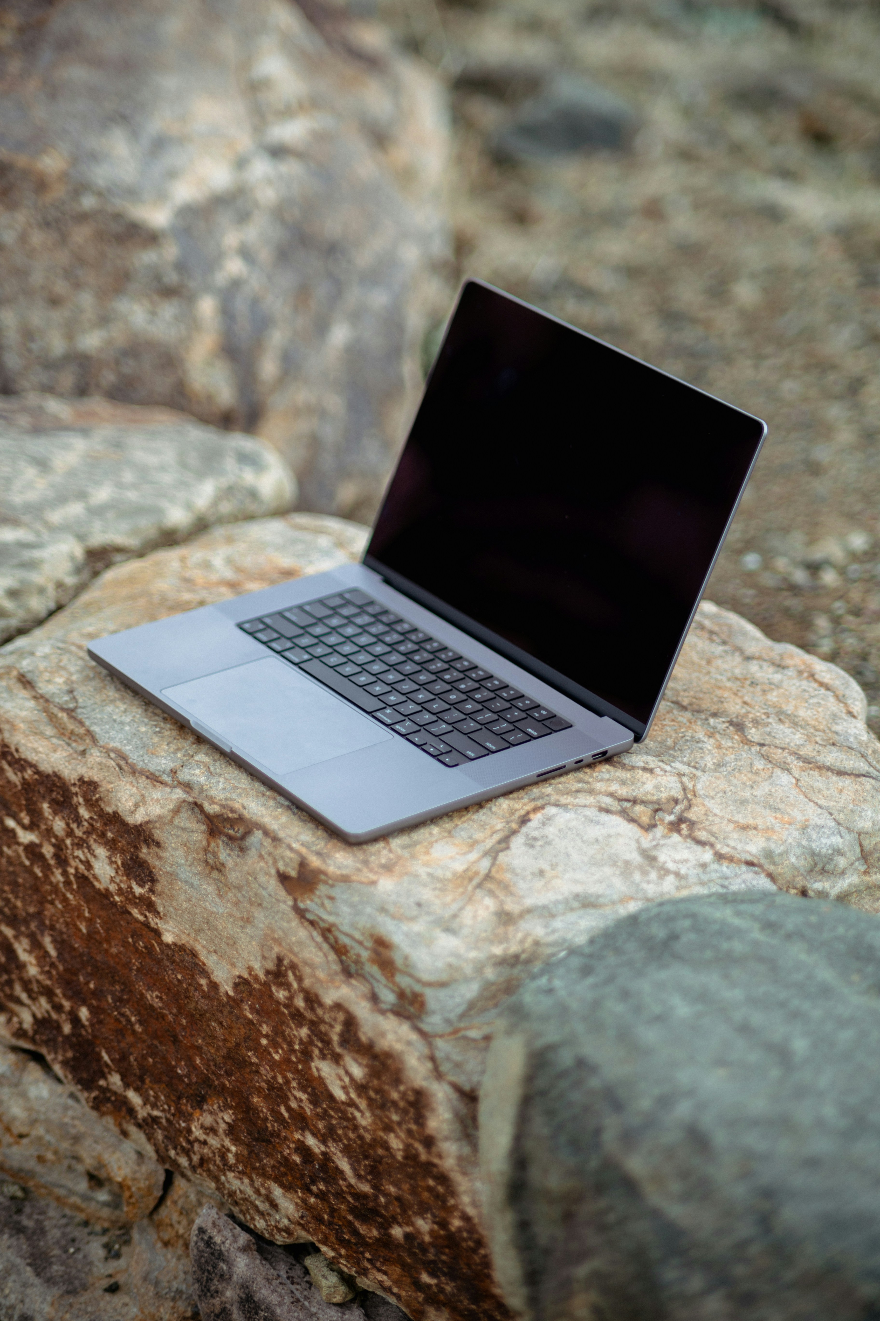 A laptop computer sitting on top of a rock photo – Free Computer Image ...