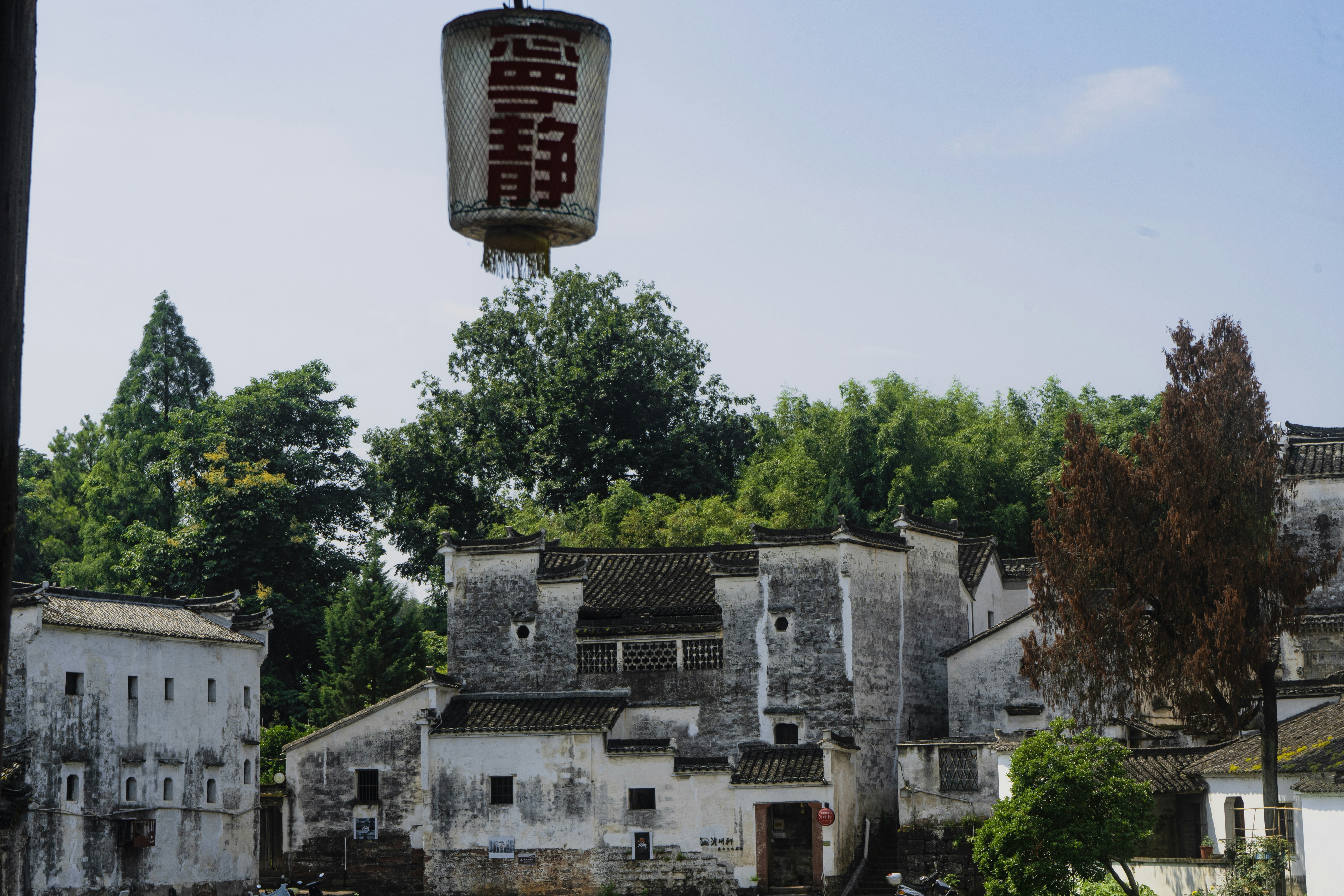 A building with a chinese sign hanging from it's side photo – Free ...