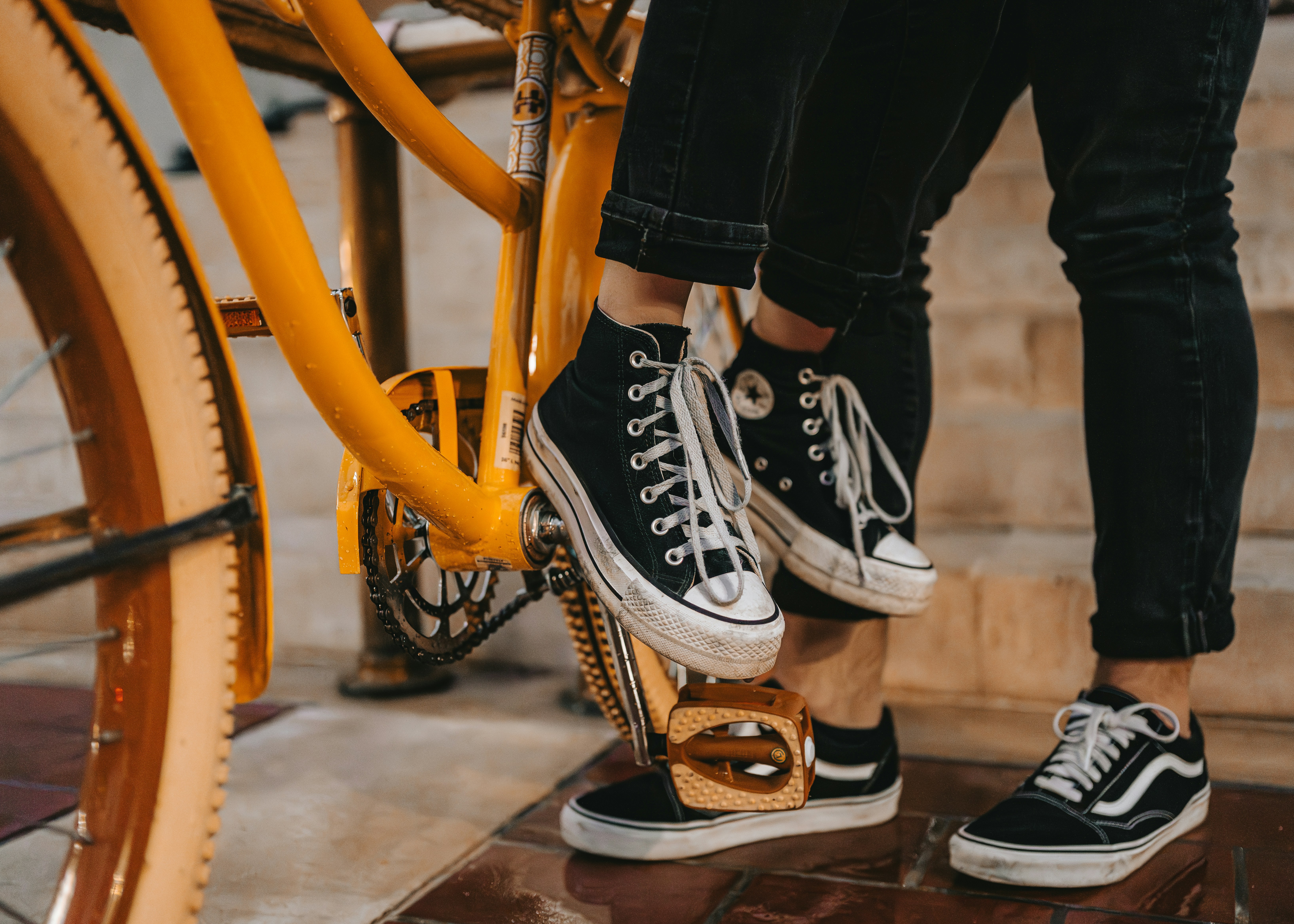 A person standing on top of a yellow bike photo – Free Bicycle Image on ...