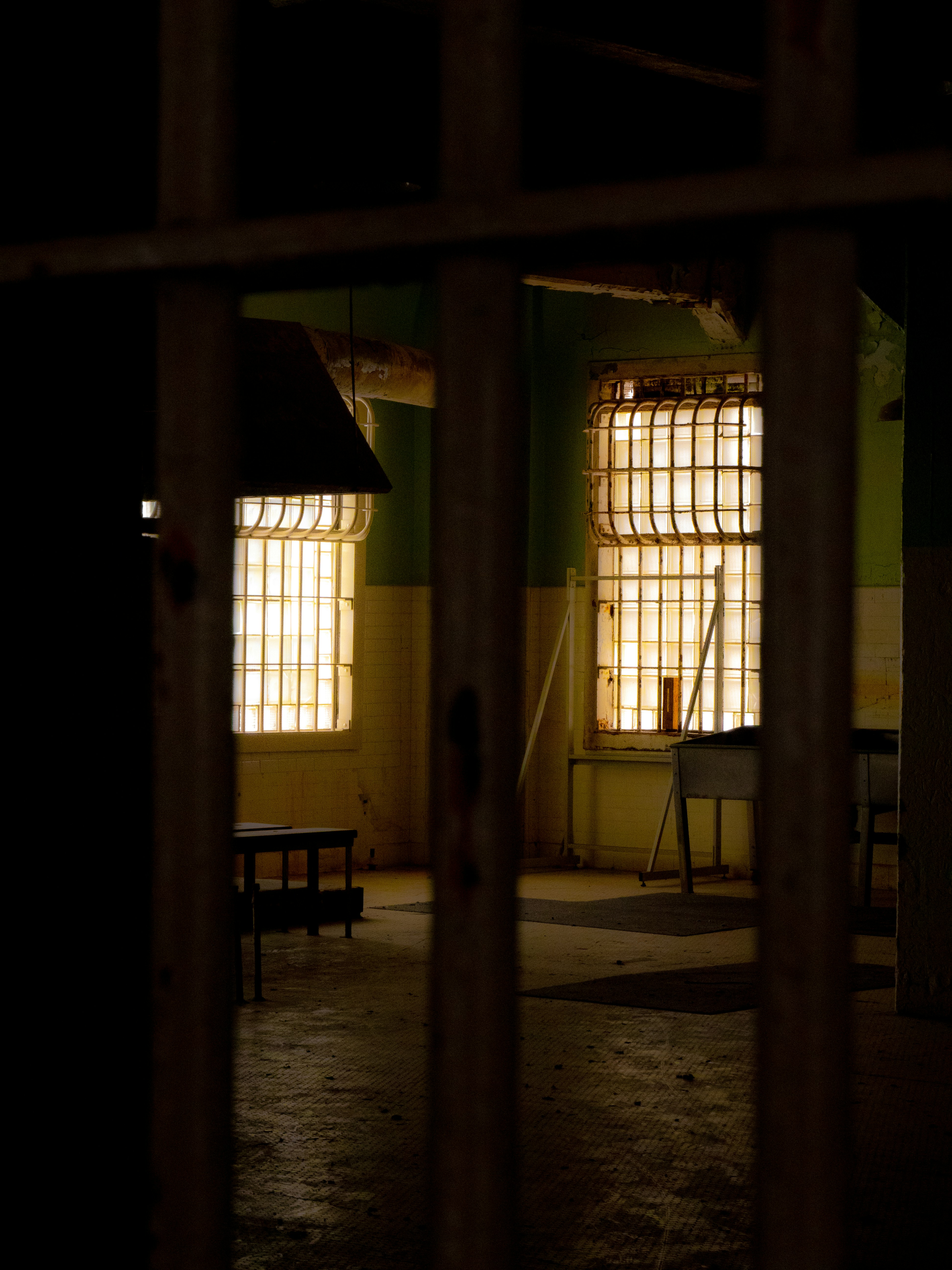 A jail cell with a bench and a window photo – Free Texture Image on ...