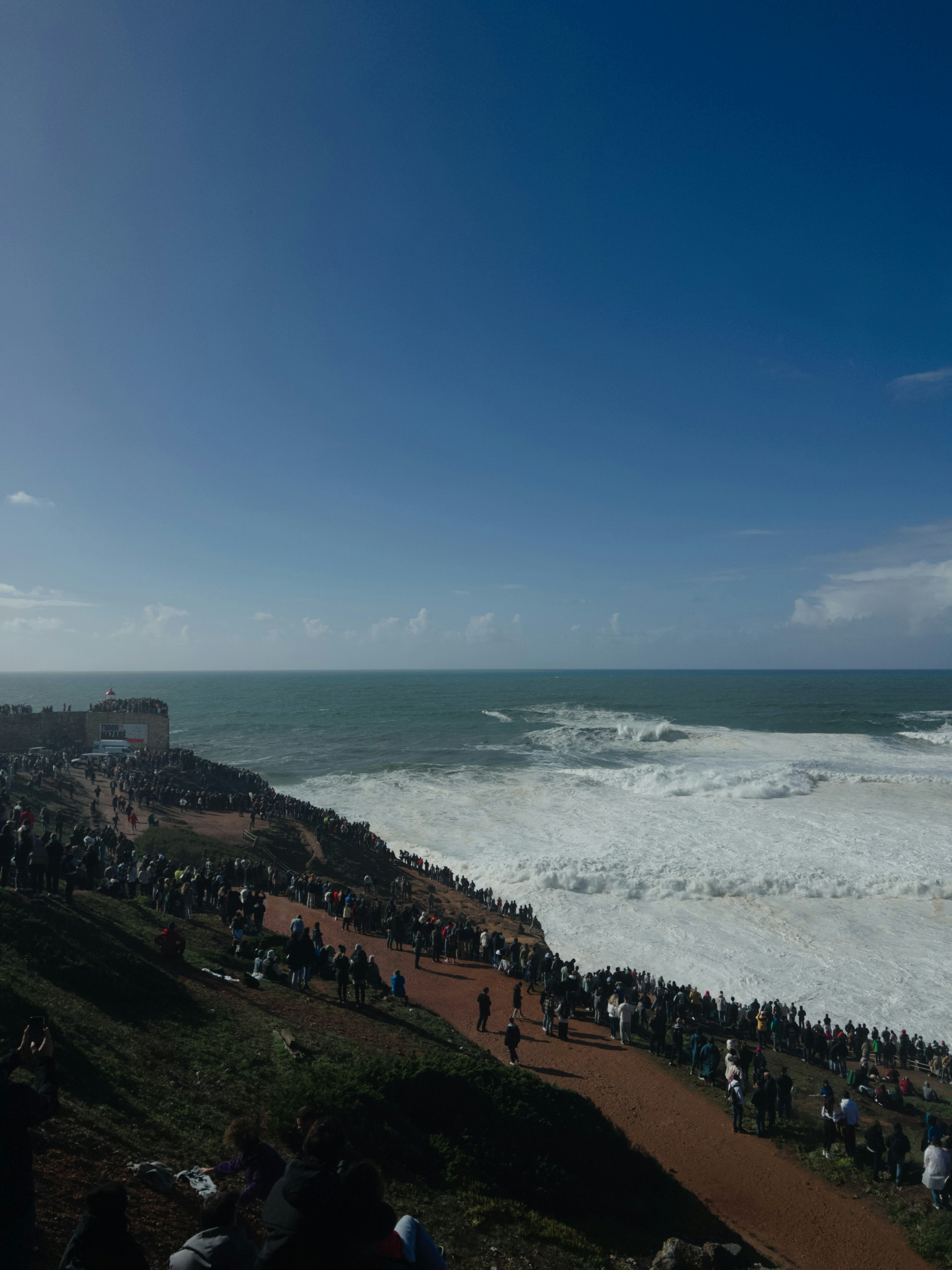 Cliffside Congregation: Spectators Lean Into the Atlantic Surge