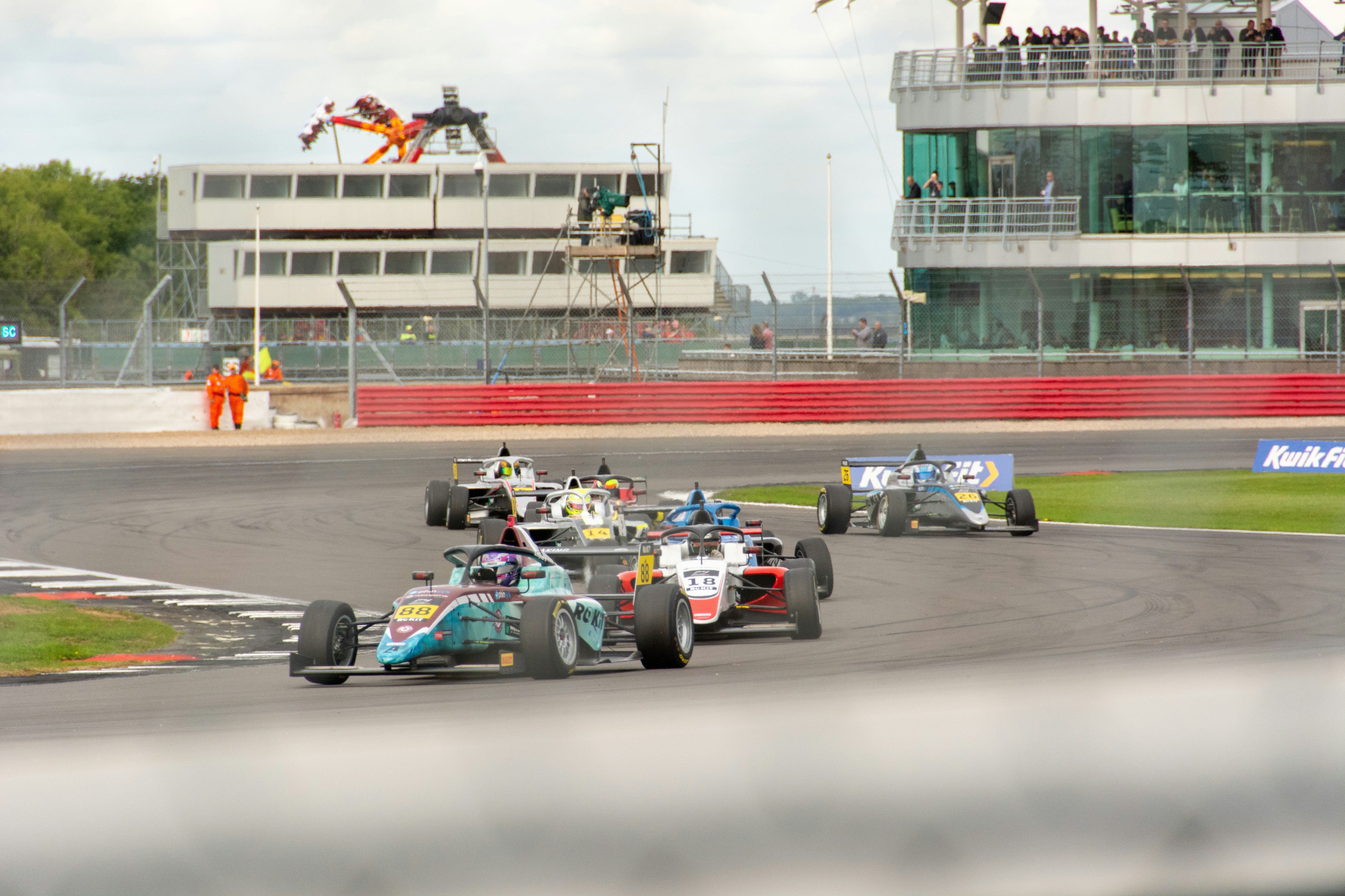 A group of racing cars driving down a race track photo – Free ...