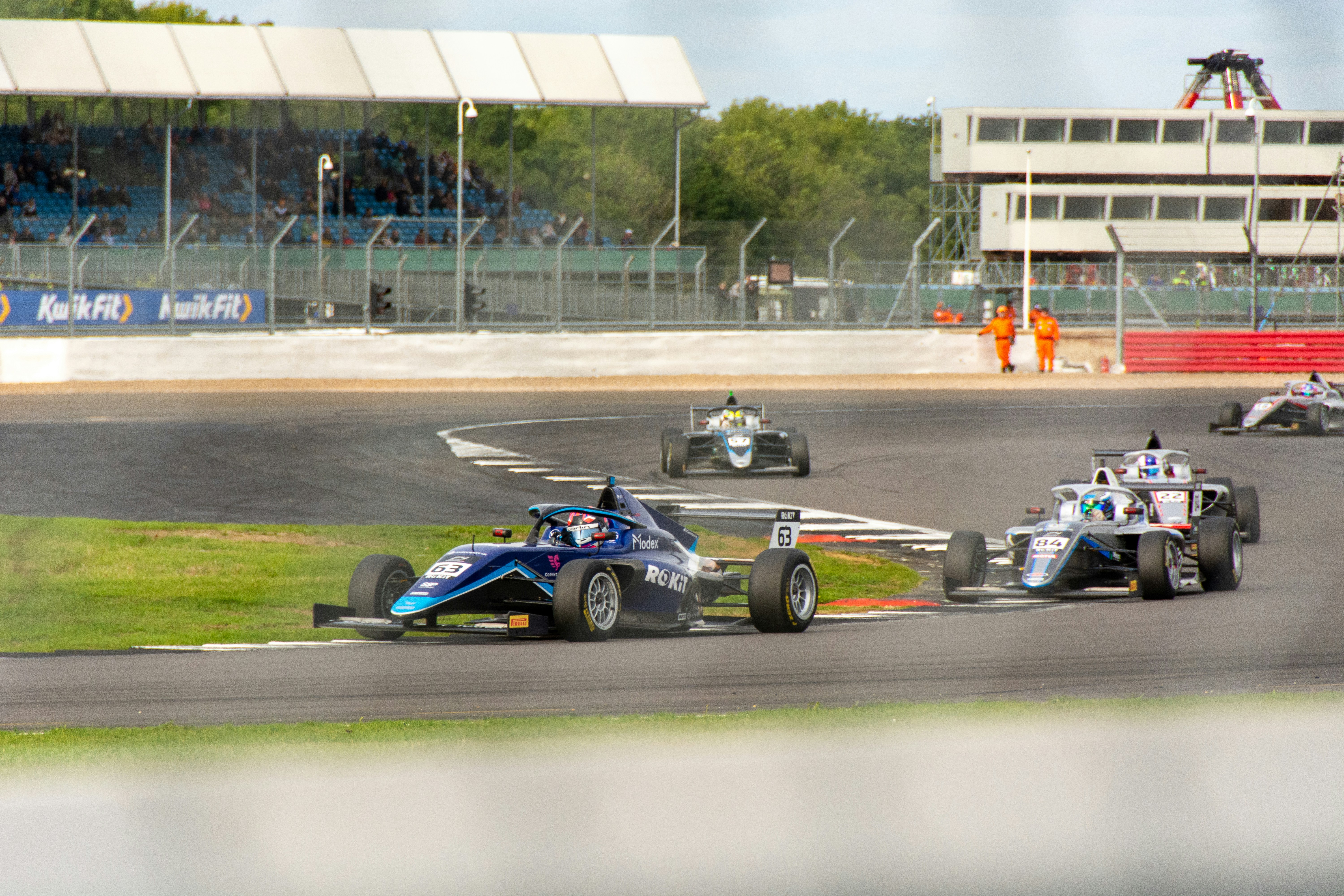 A group of racing cars on a race track photo – Free Grey Image on Unsplash