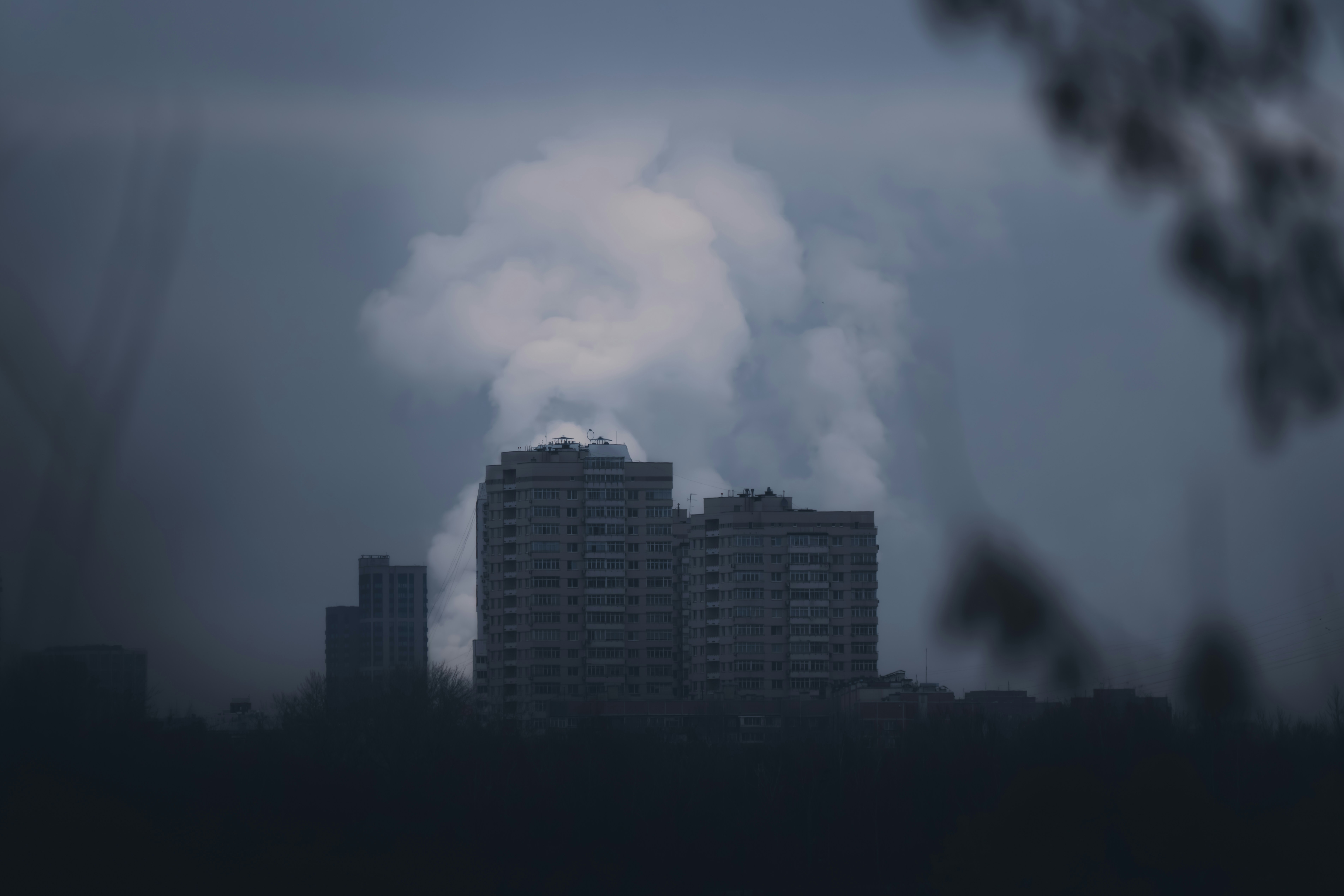 Blue-Hour Plume Over a Quiet City Skyline