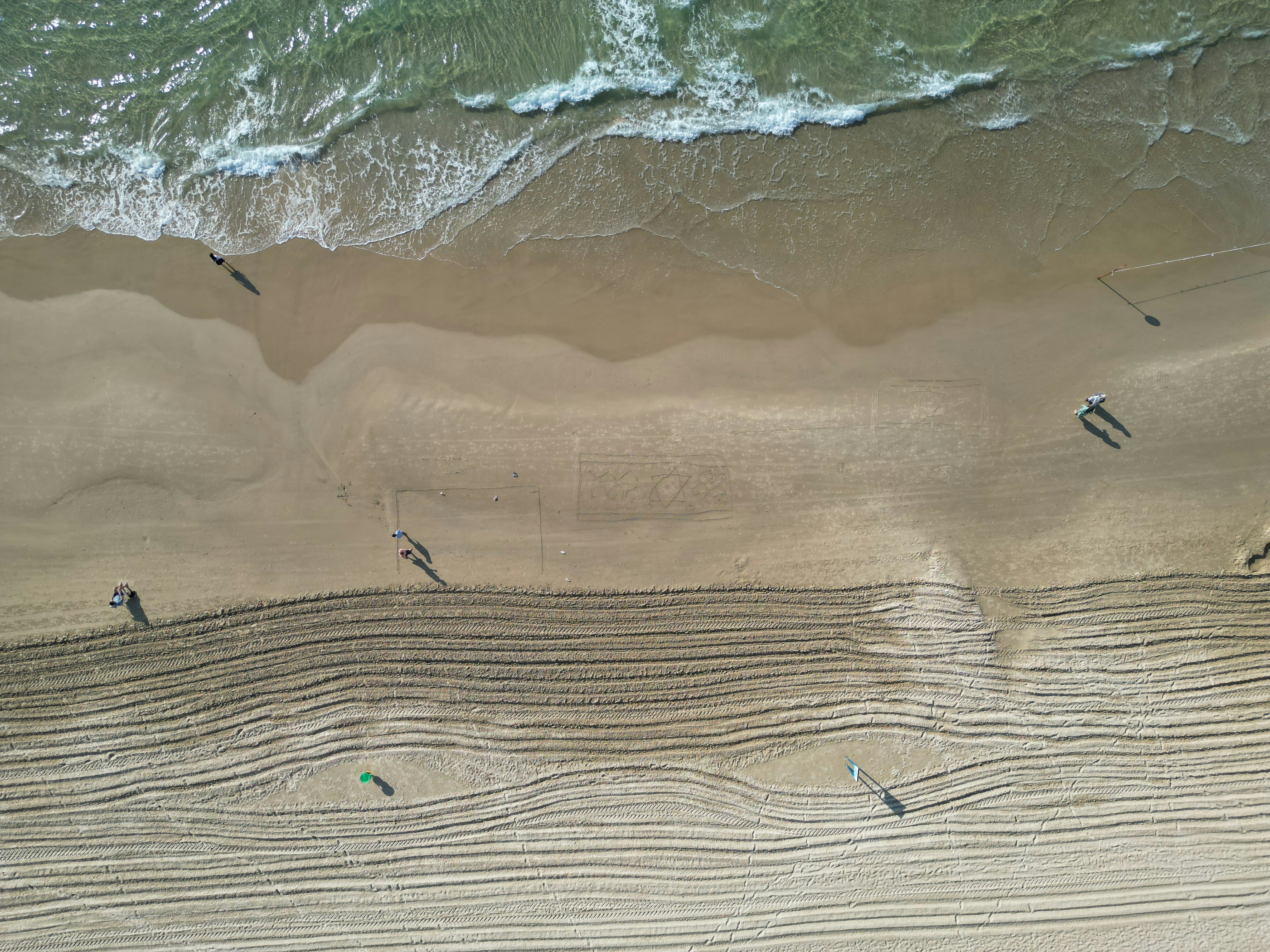 Green Parasol Amid Sand-Ridge Lines: A Drone Beach Study