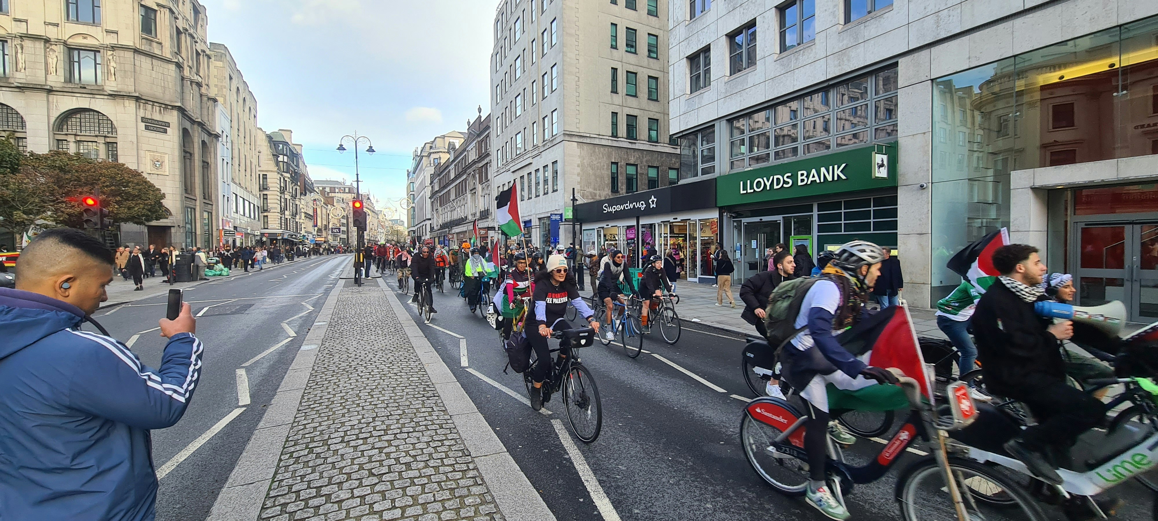 A group of people riding bikes down a street photo – Free Human Image ...