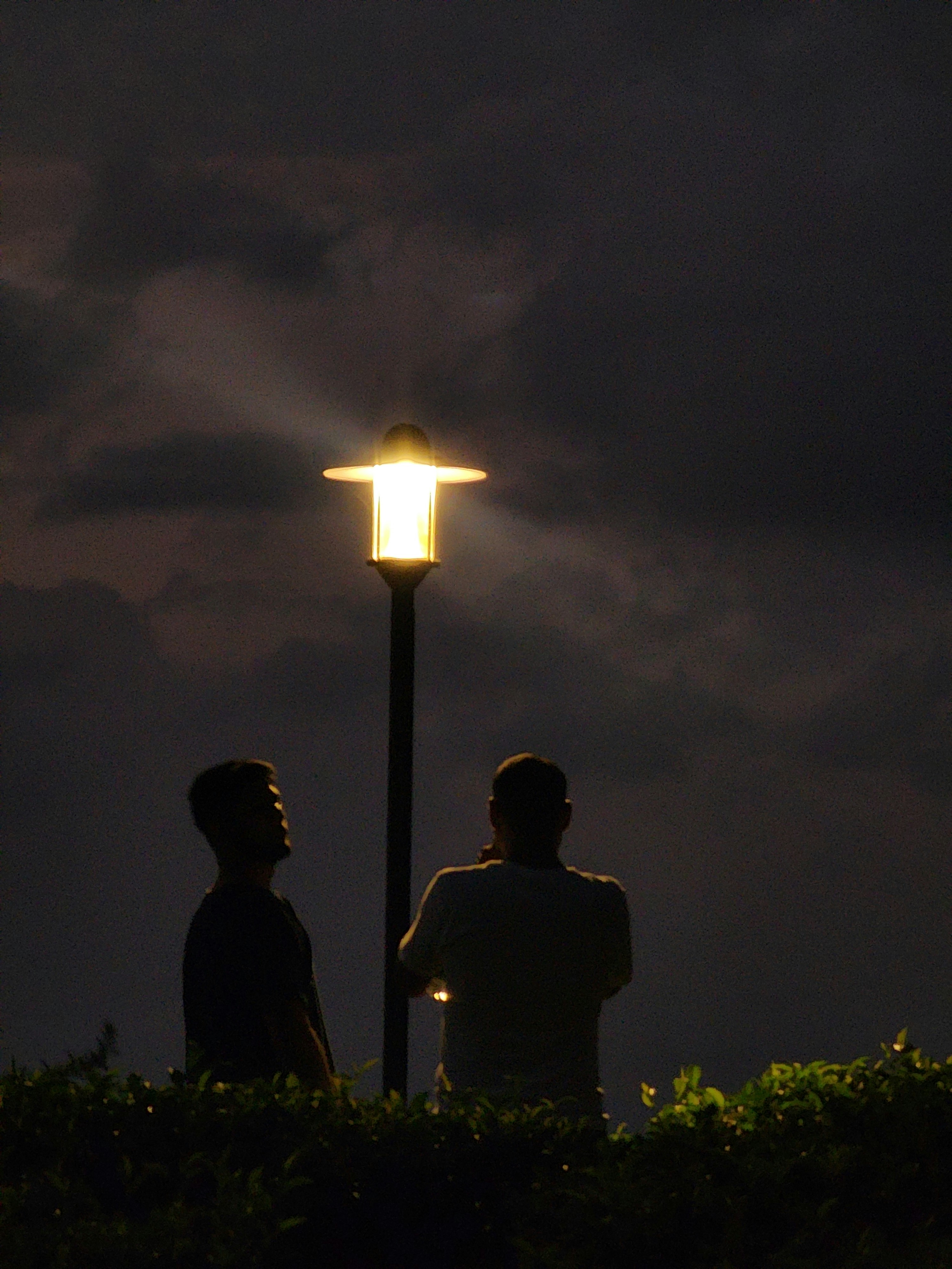 Lantern Glow Between Silent Figures