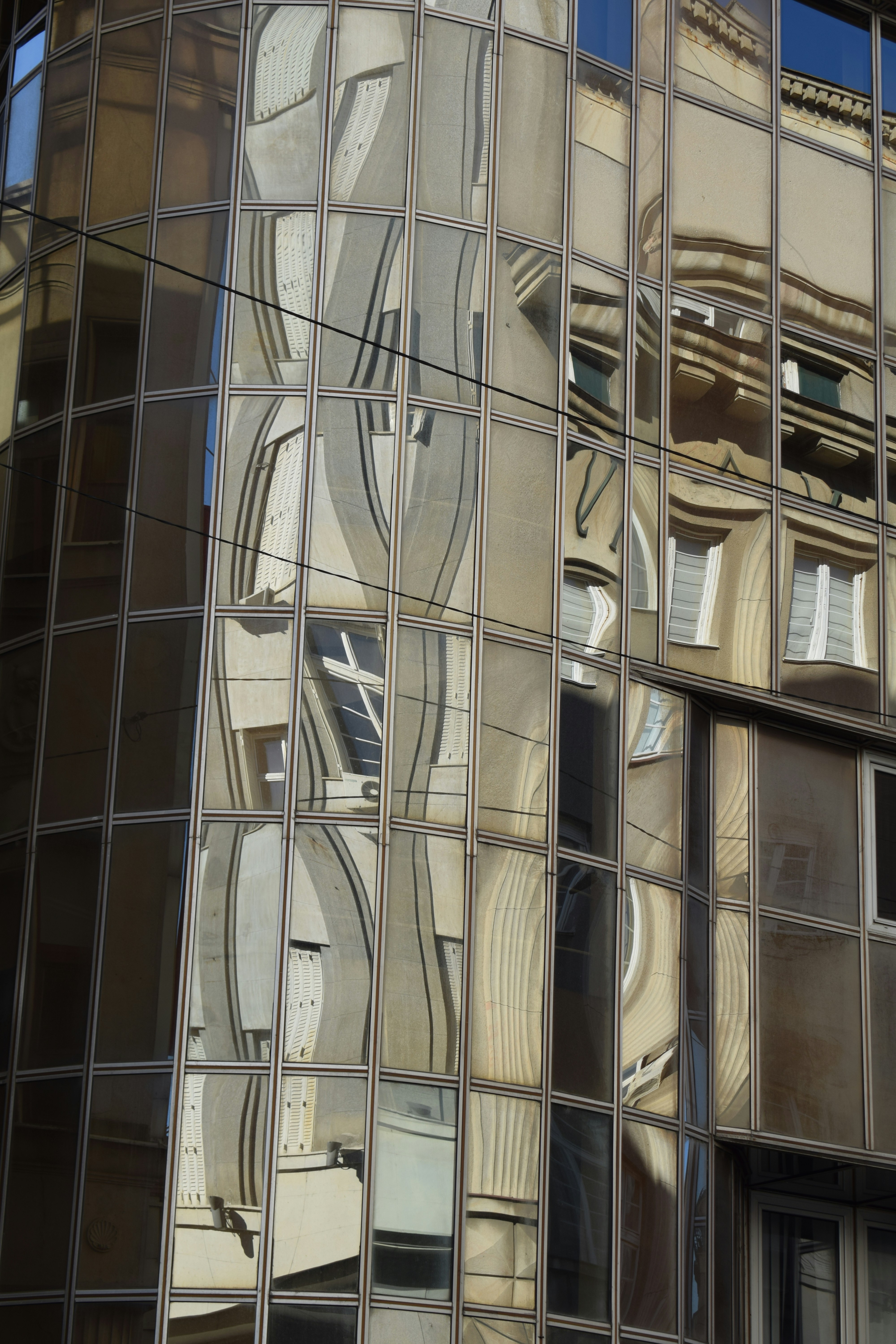 Distorted Cityscape Woven into a Glass Grid