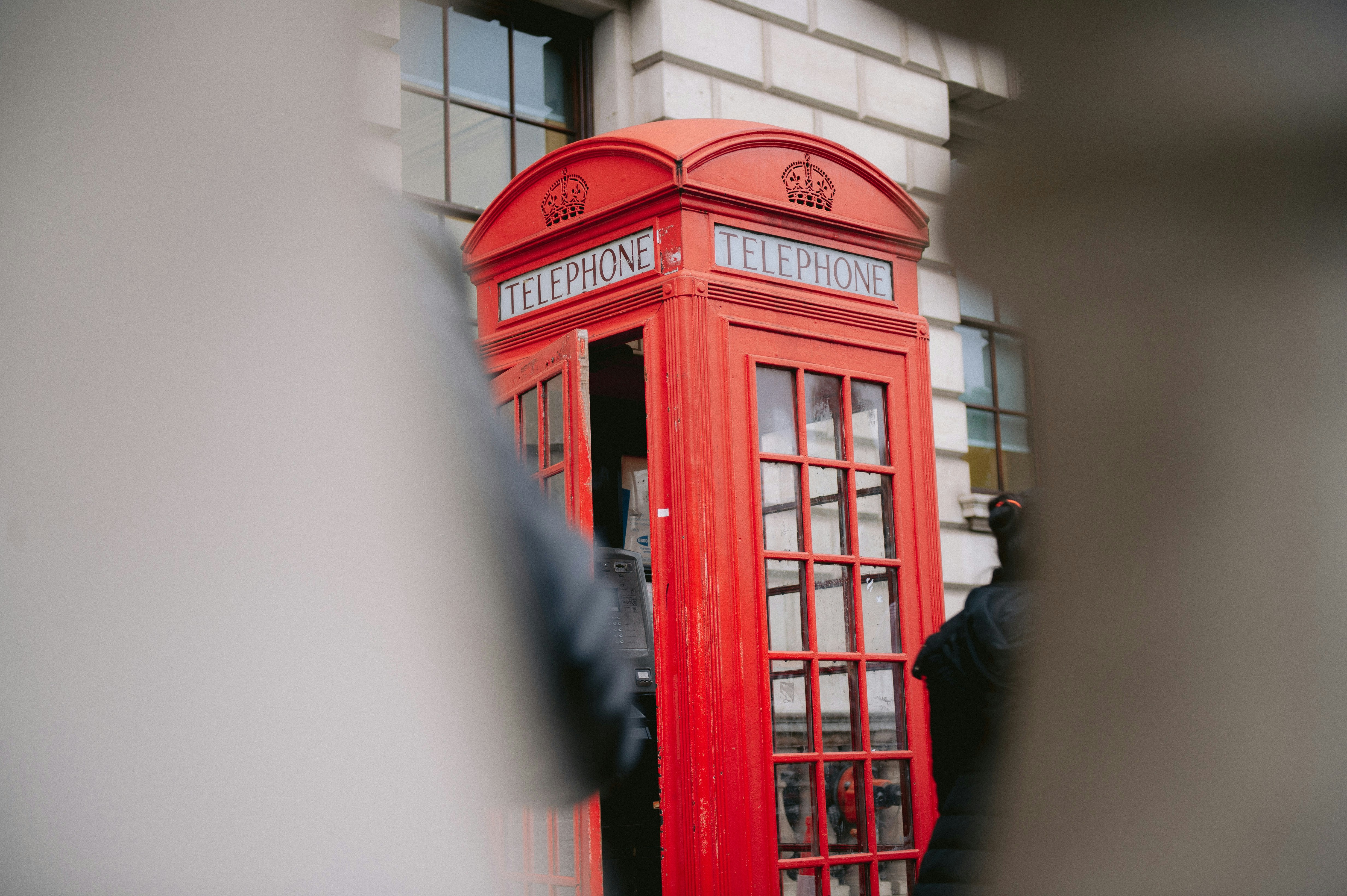 A red telephone booth in front of a building photo – Free Westminster ...