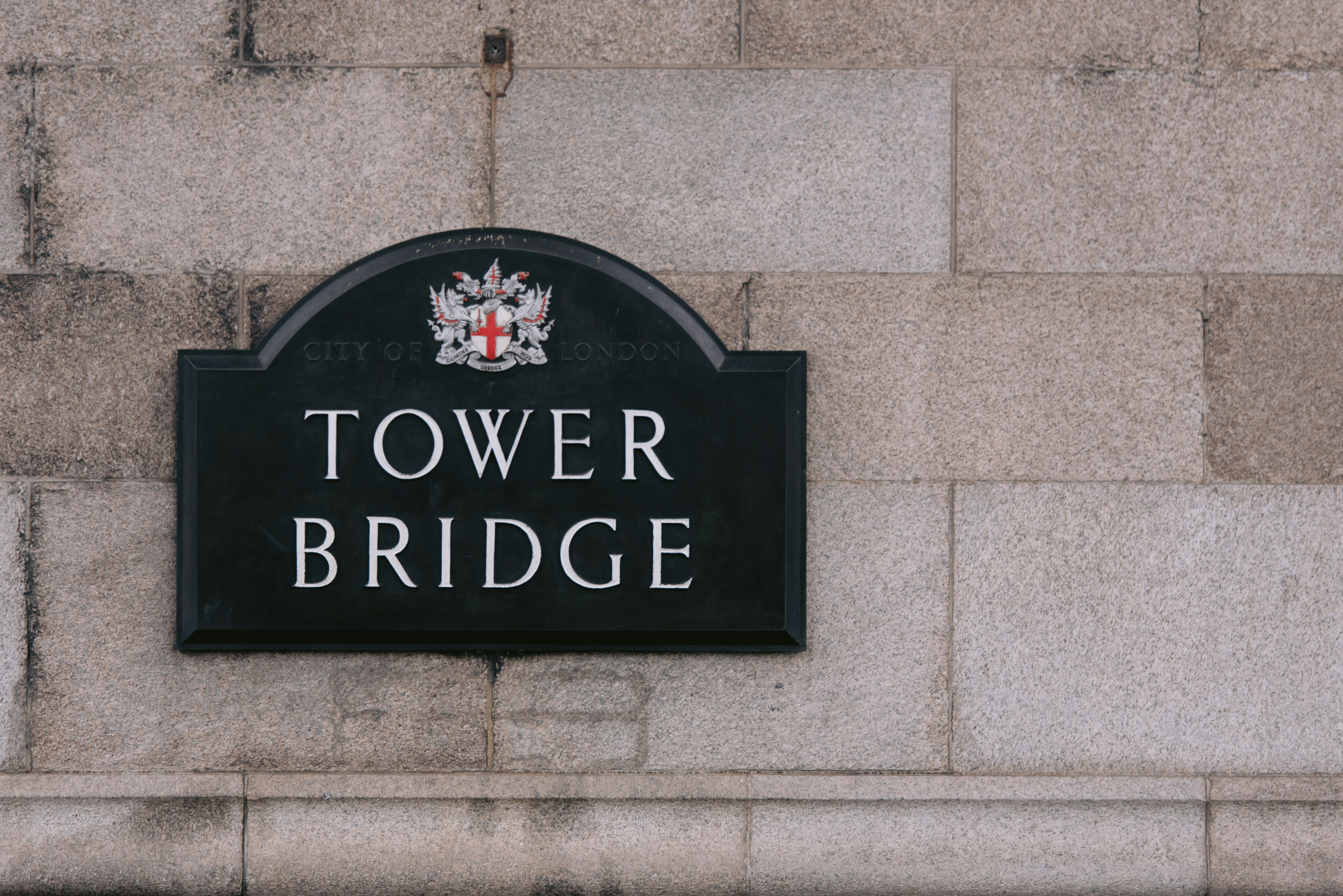 A sign on the side of a building that says tower bridge photo – Free ...
