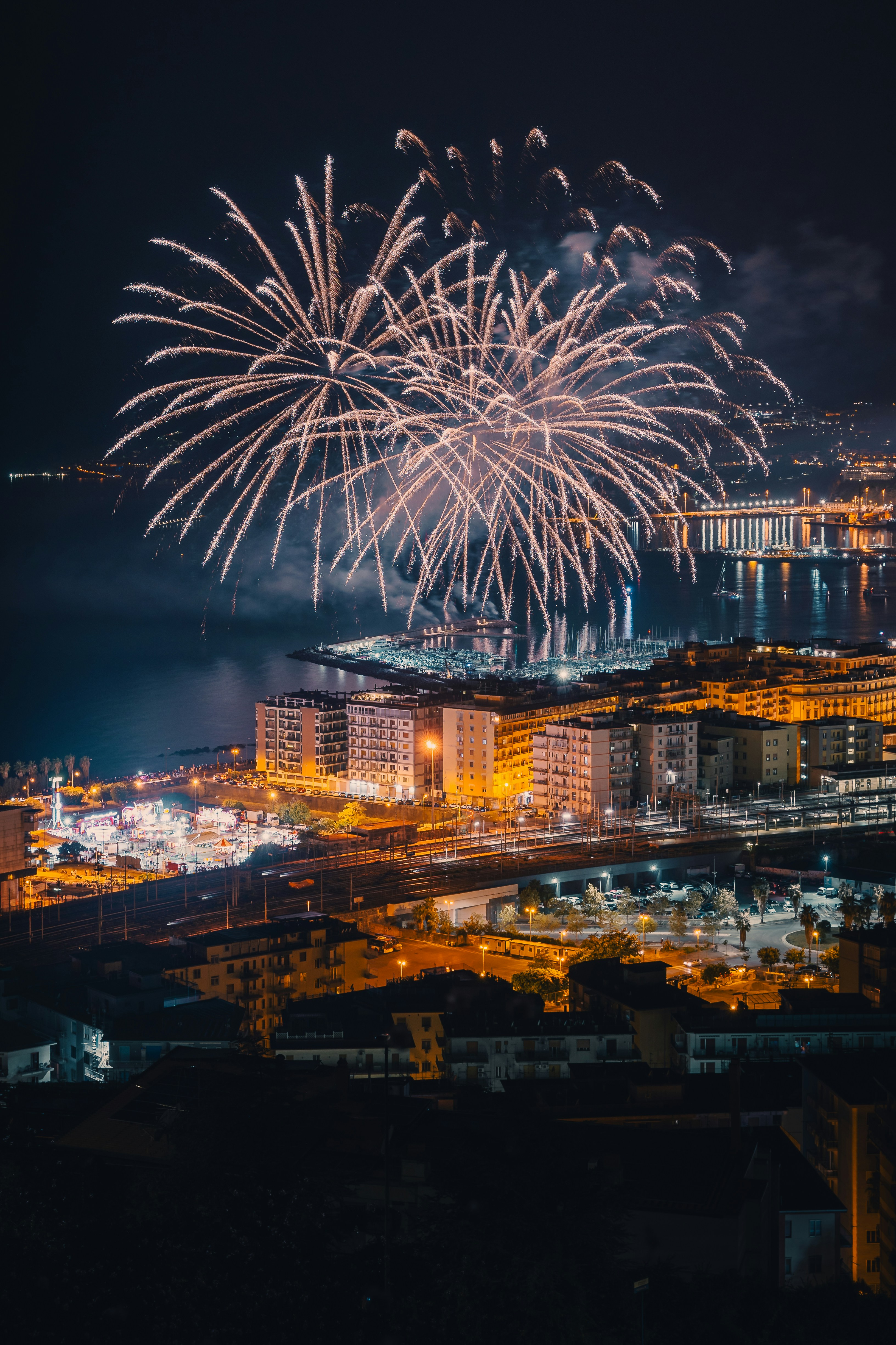 Fireworks are lit up in the night sky over a city photo – Free Salerno ...