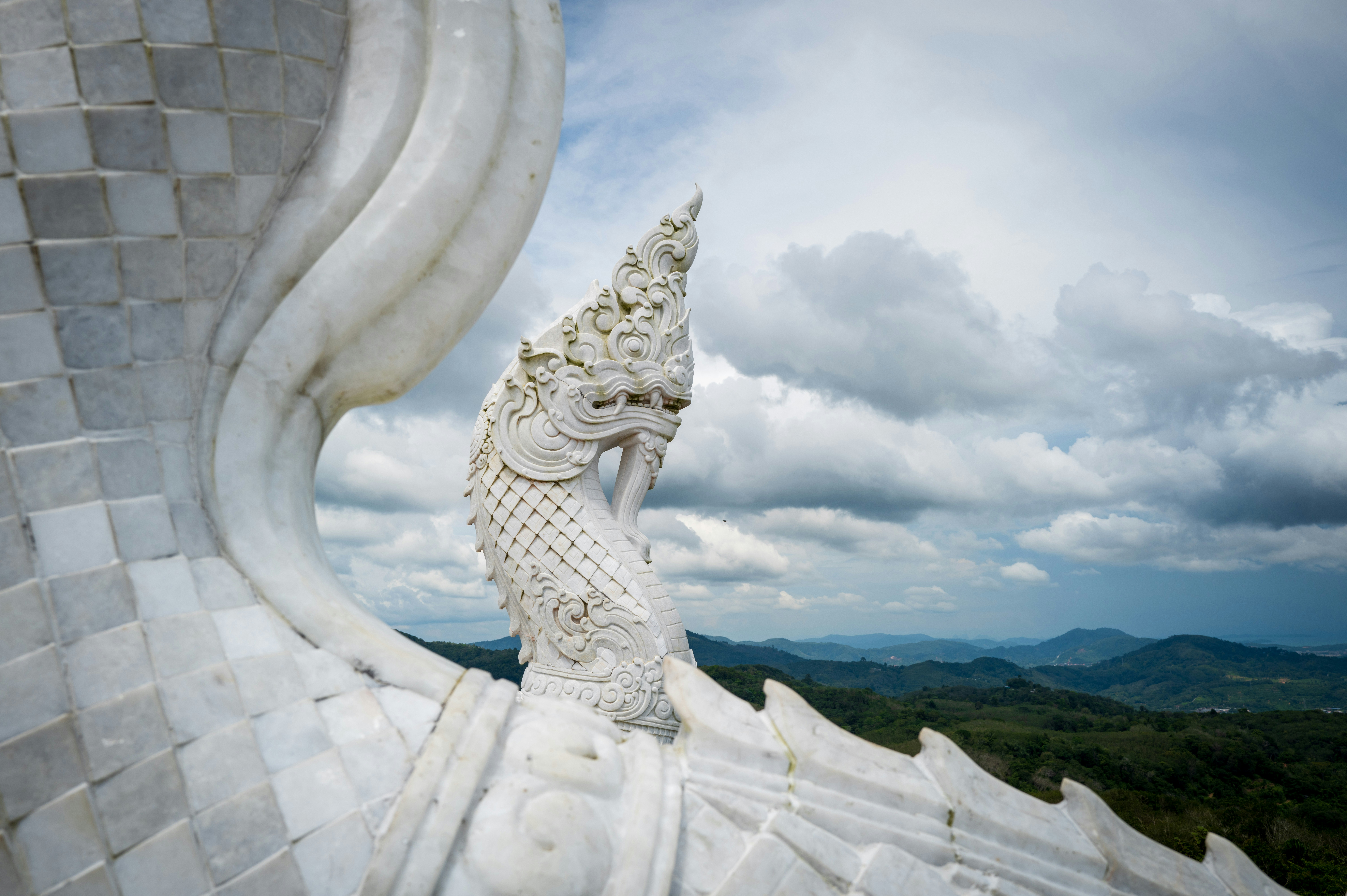 Dragon's Crest on a White Temple Roof Overlooking a Rolling Valley