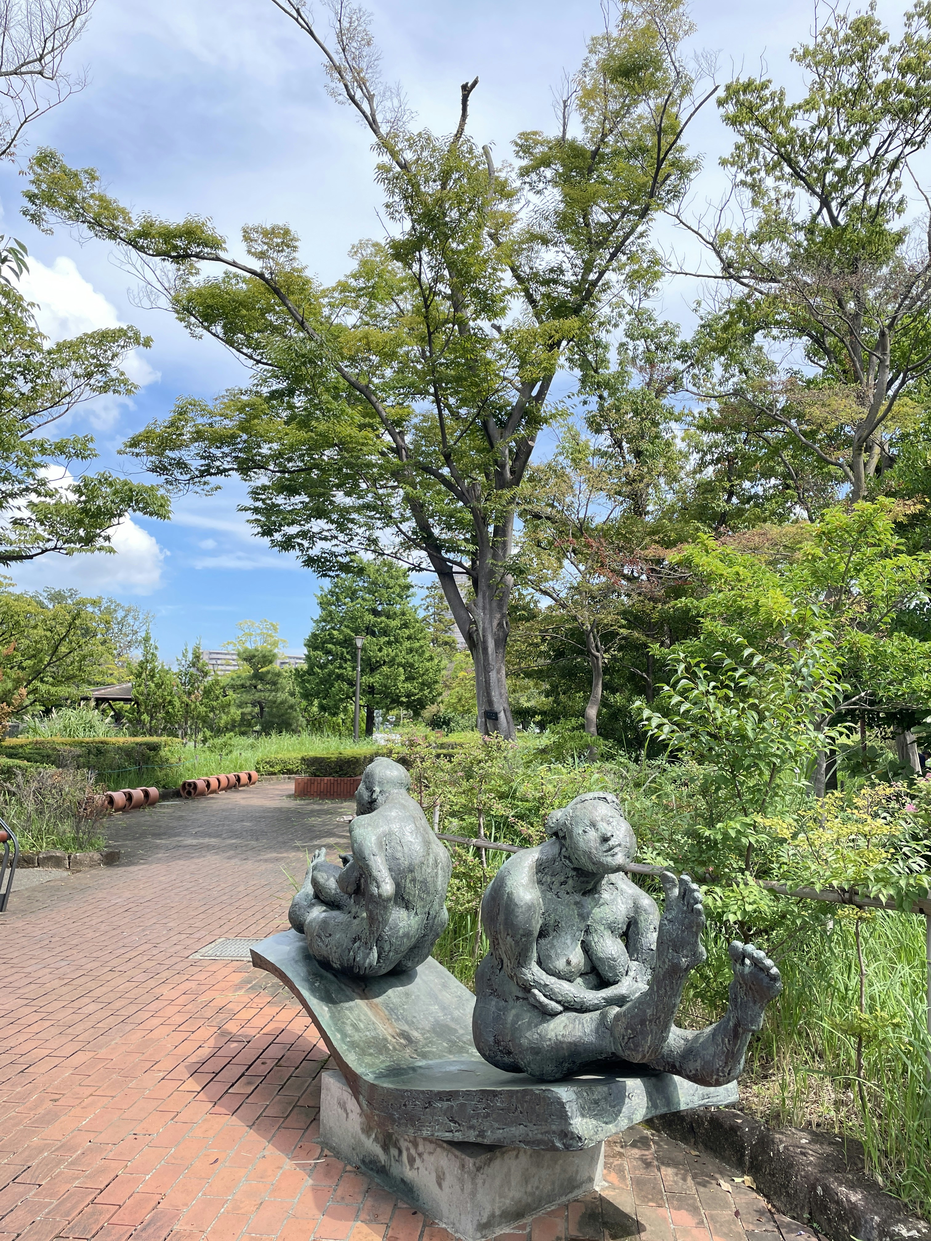 Bronze Companions on a Sunlit Park Bench