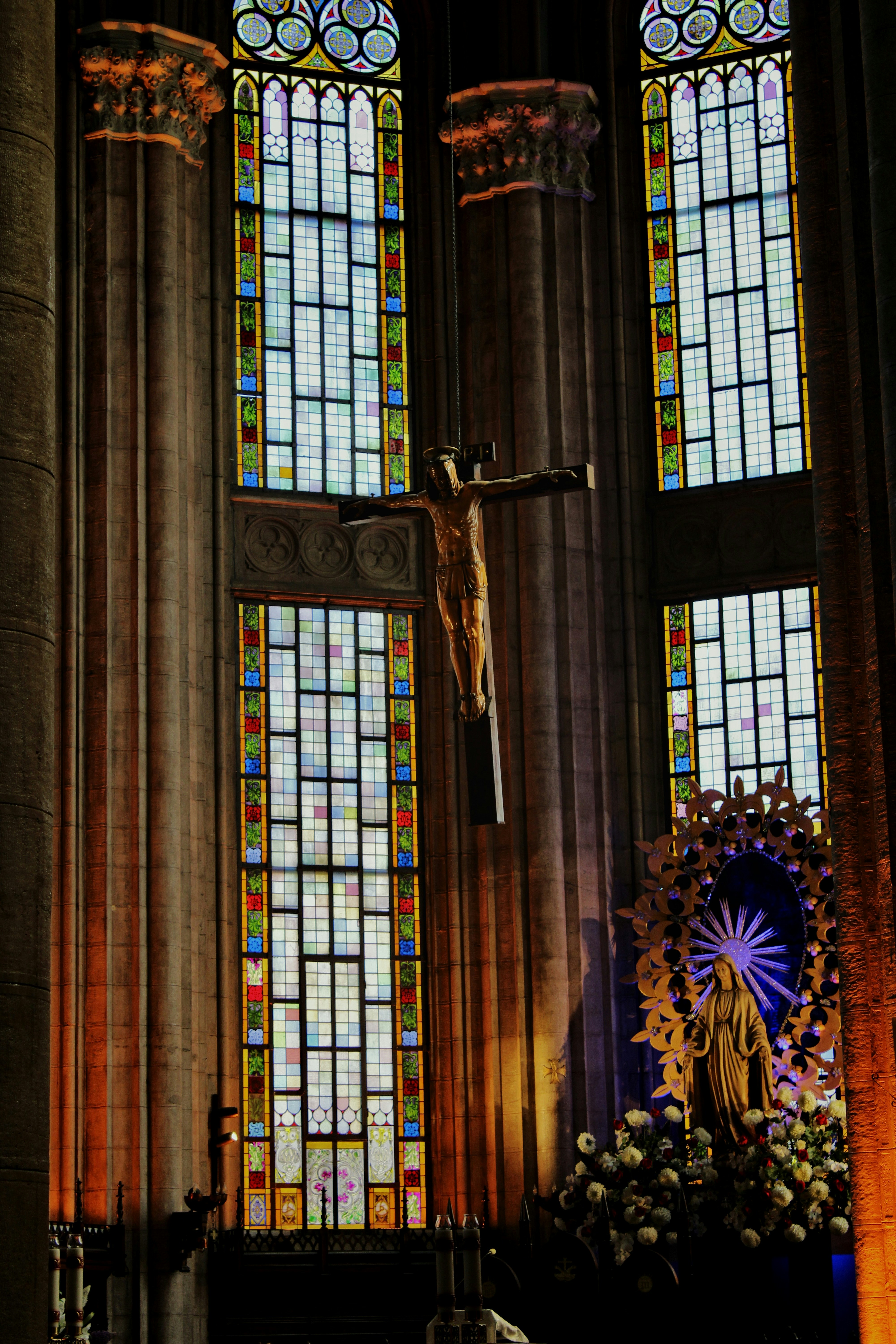 A crucifix in front of a stained glass window photo – Free Cross Image ...